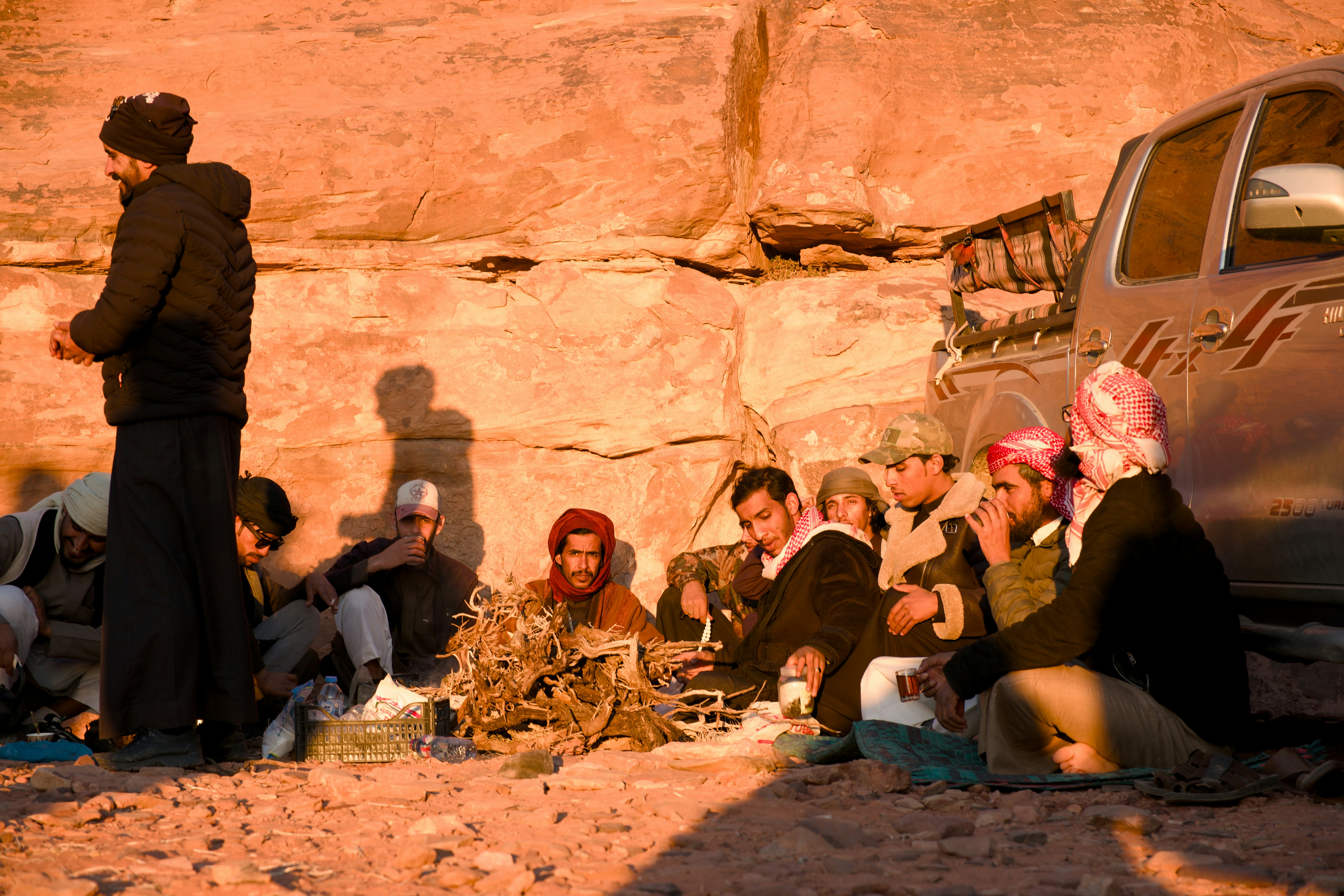 Desert Camp After Sundown: Faces and Shadows Gathered Around Quiet Fire
