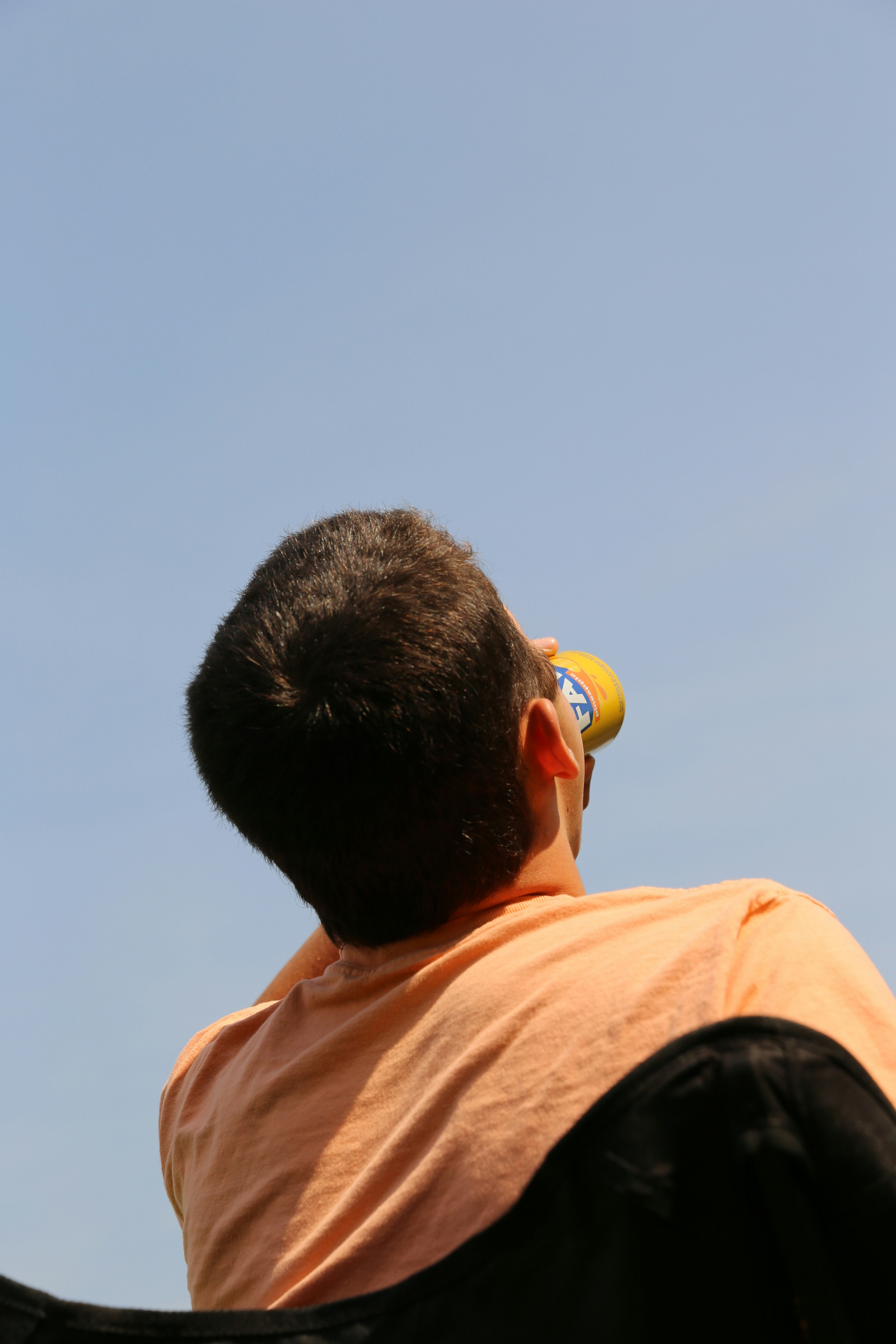 Against the Blue: A Sunlit Portrait from Behind