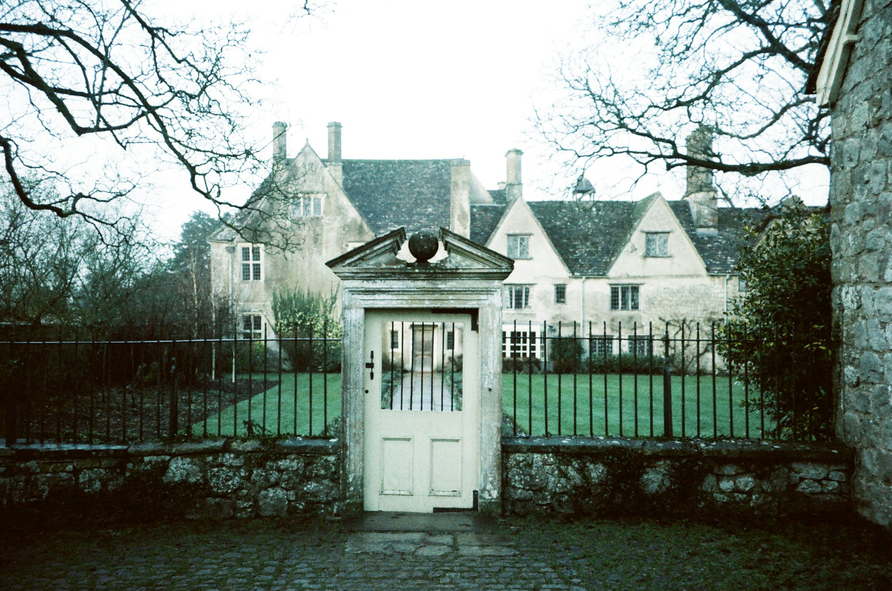 A grand stone manor house with a white gate. photo – Free Architecture ...