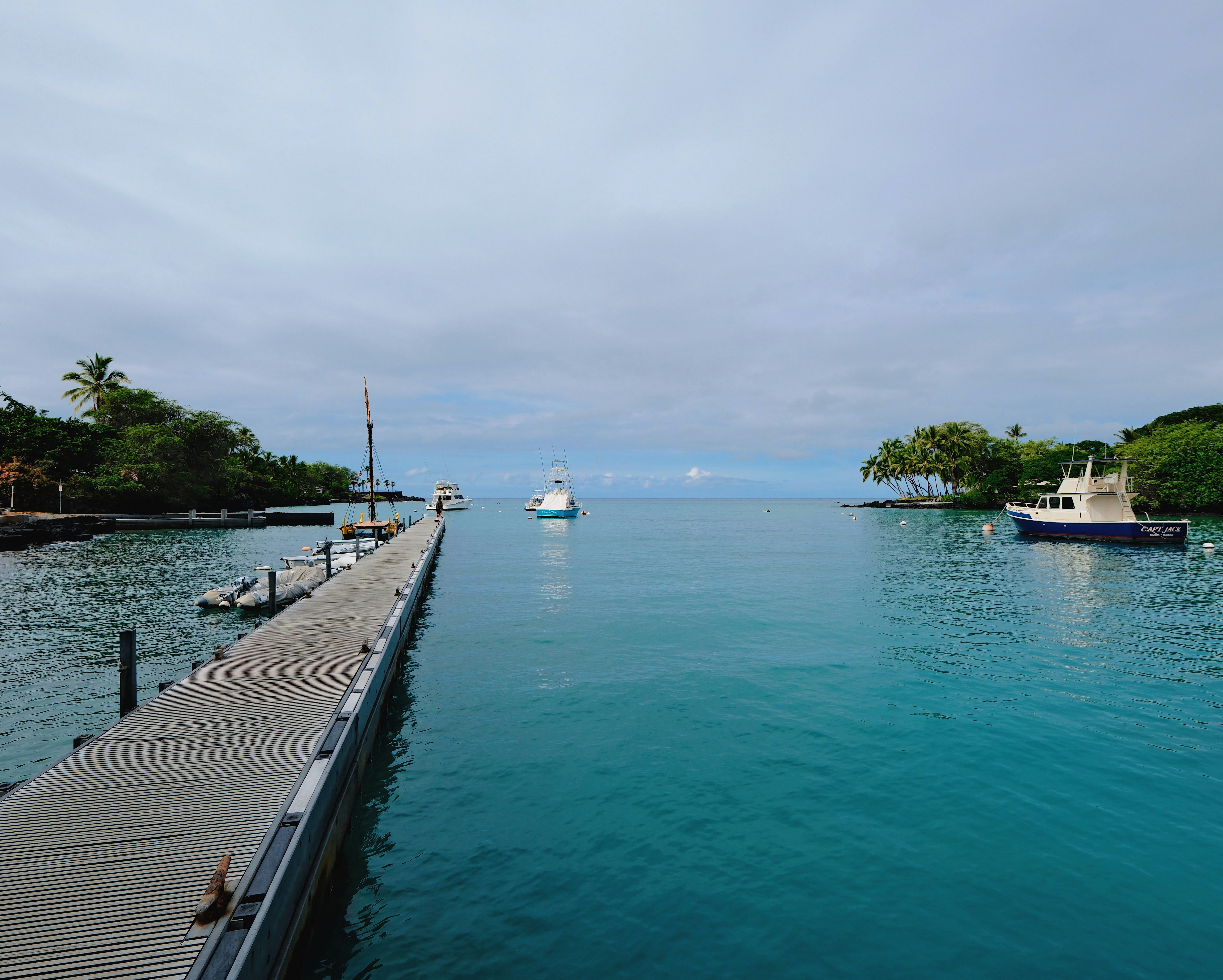 Azure Horizon: Boats at the End of a Wooden Pier