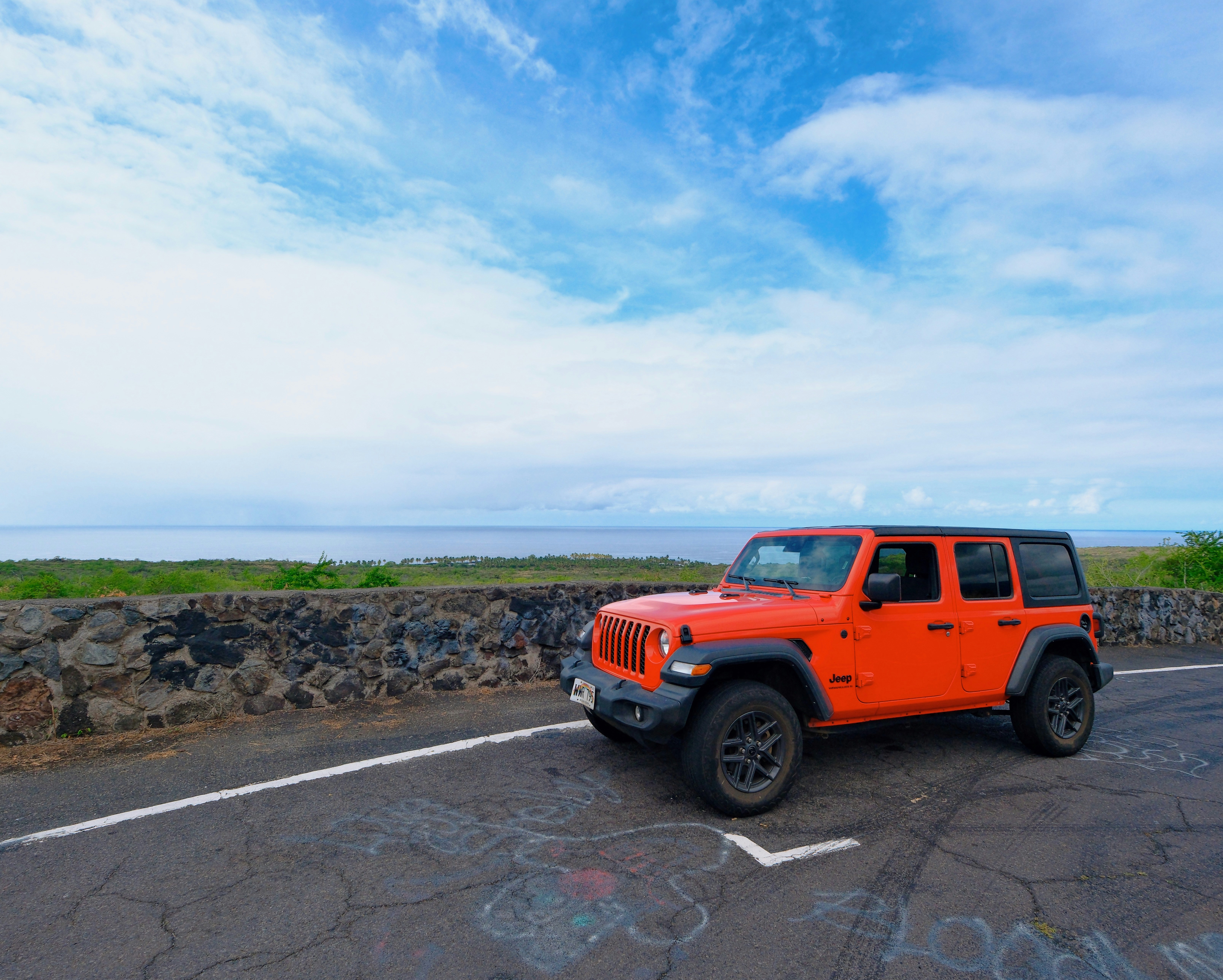 Orange Jeep on a Sea-View Road