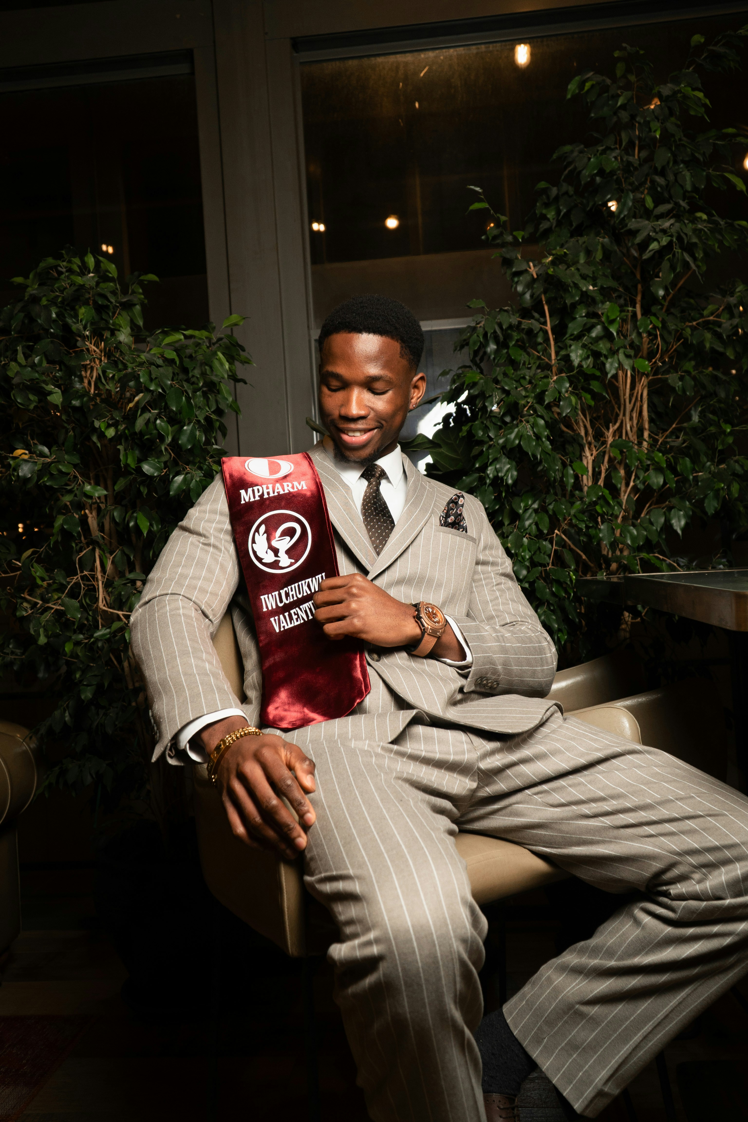 Sartorial Confidence: A Groomed Gentleman Reclines with Honor at the Lounge