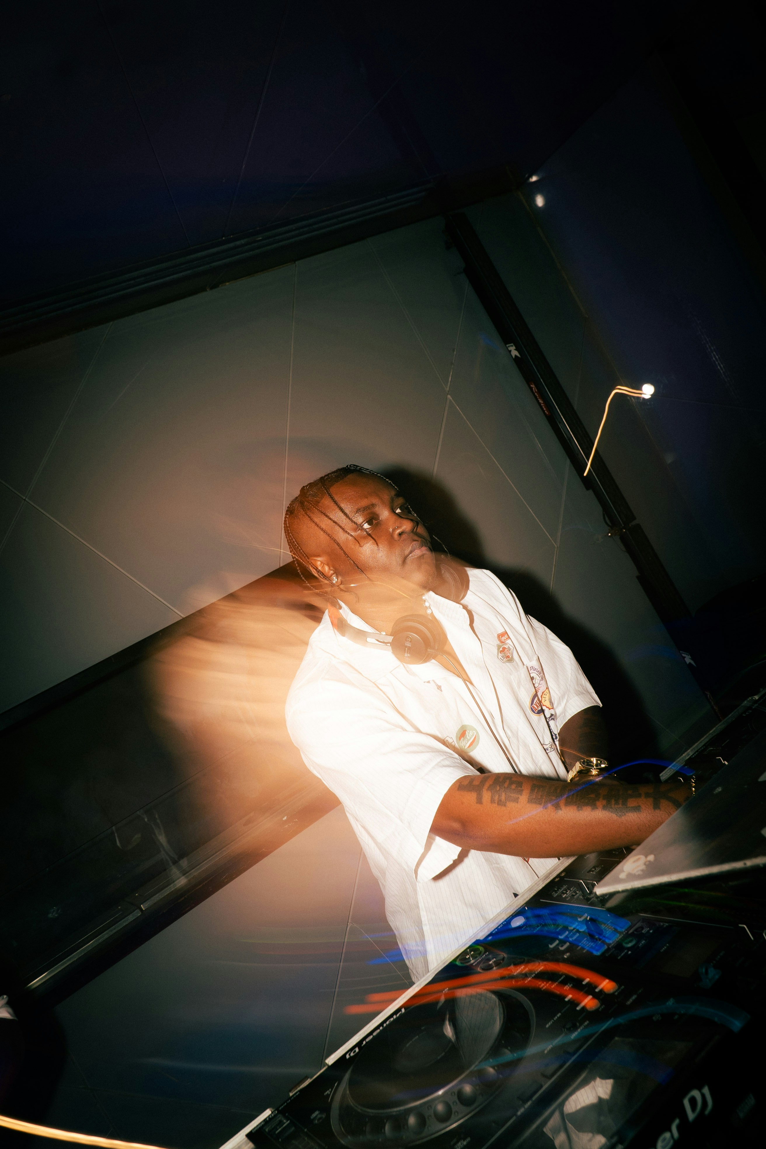 Midnight Spin: DJ in Motion Under Neon Trails