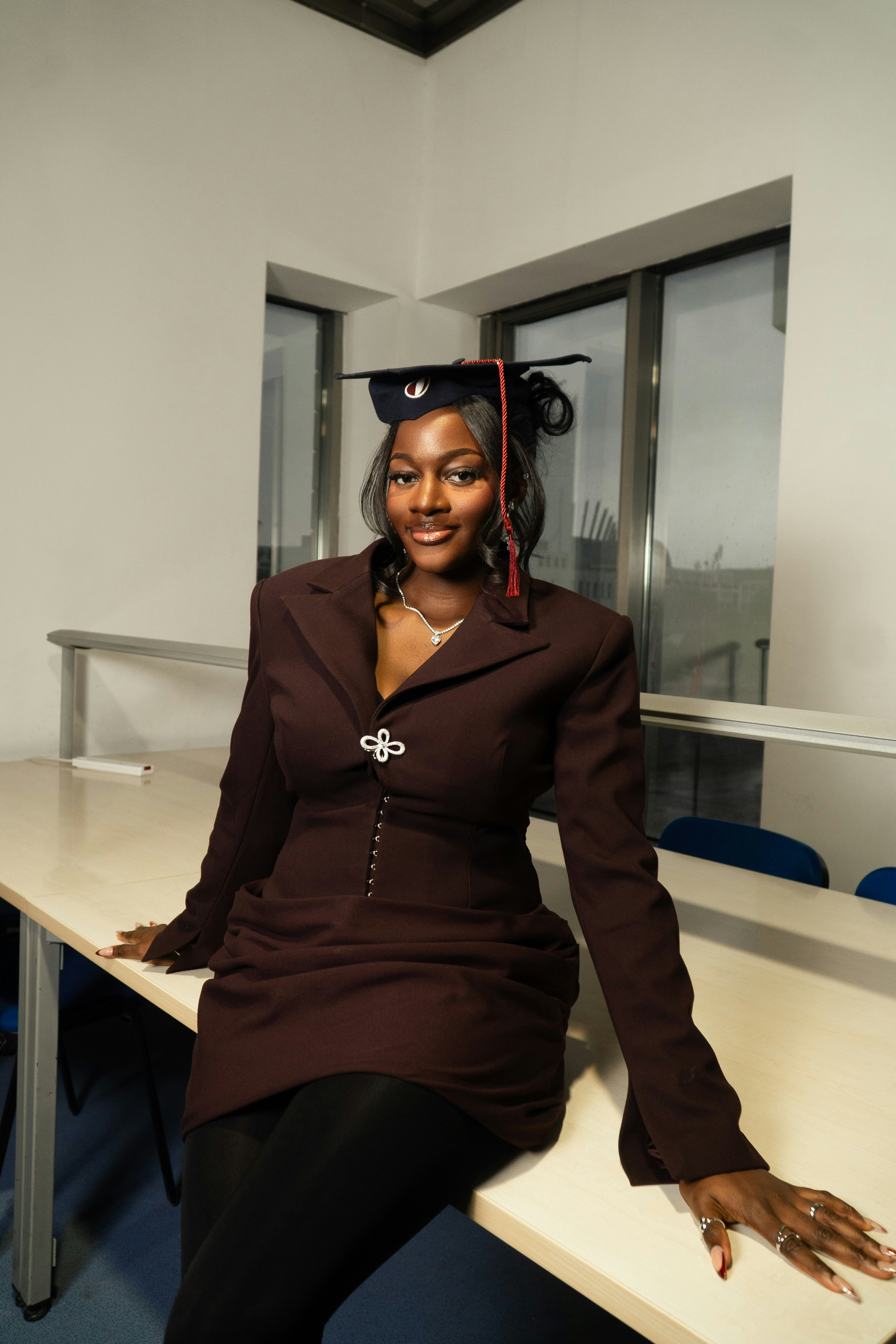 Graduate Flair: Confident Poise in a Modern Office Studio