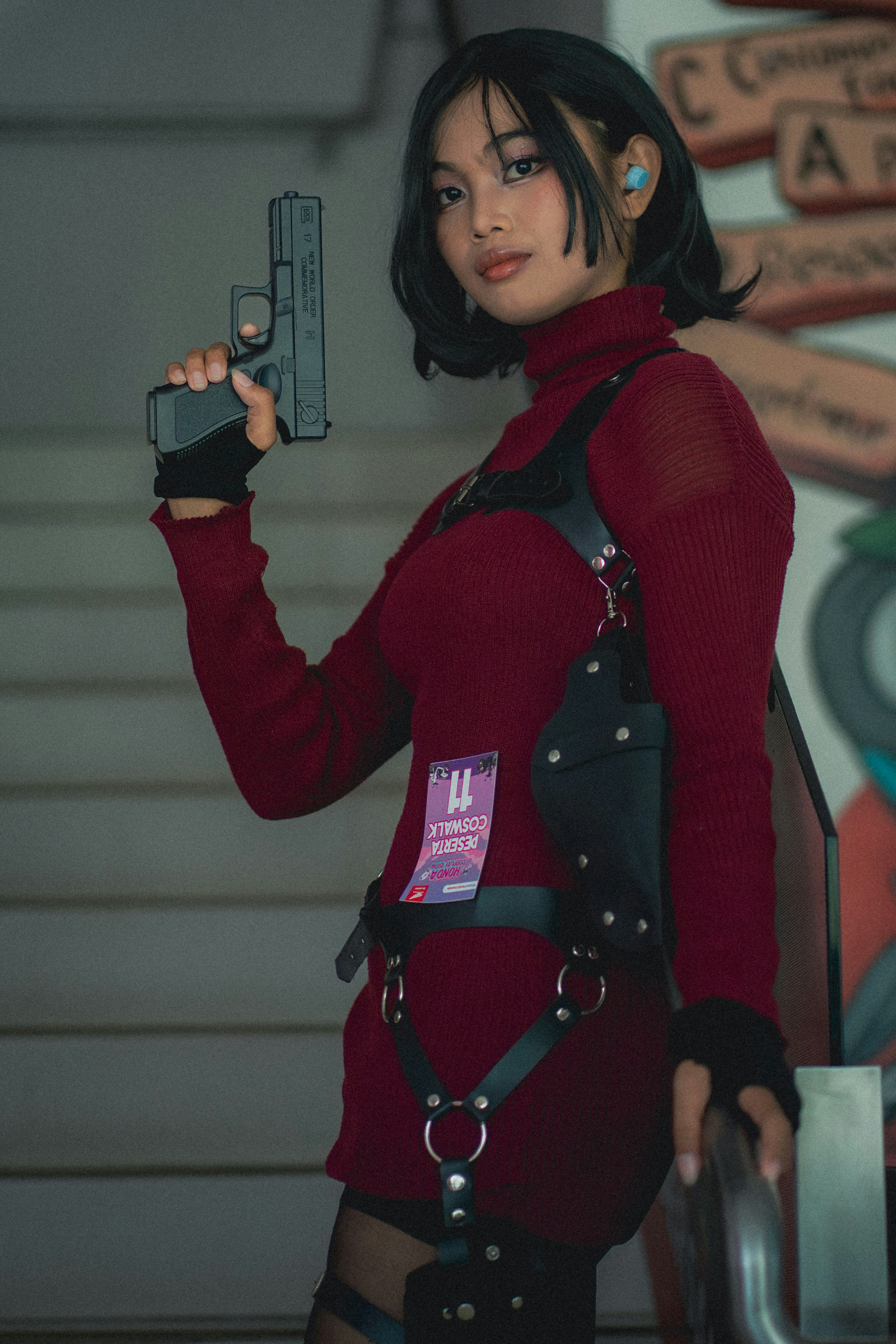 Red turtleneck, cool resolve: a hoodie harnessed by a confident pistol of style