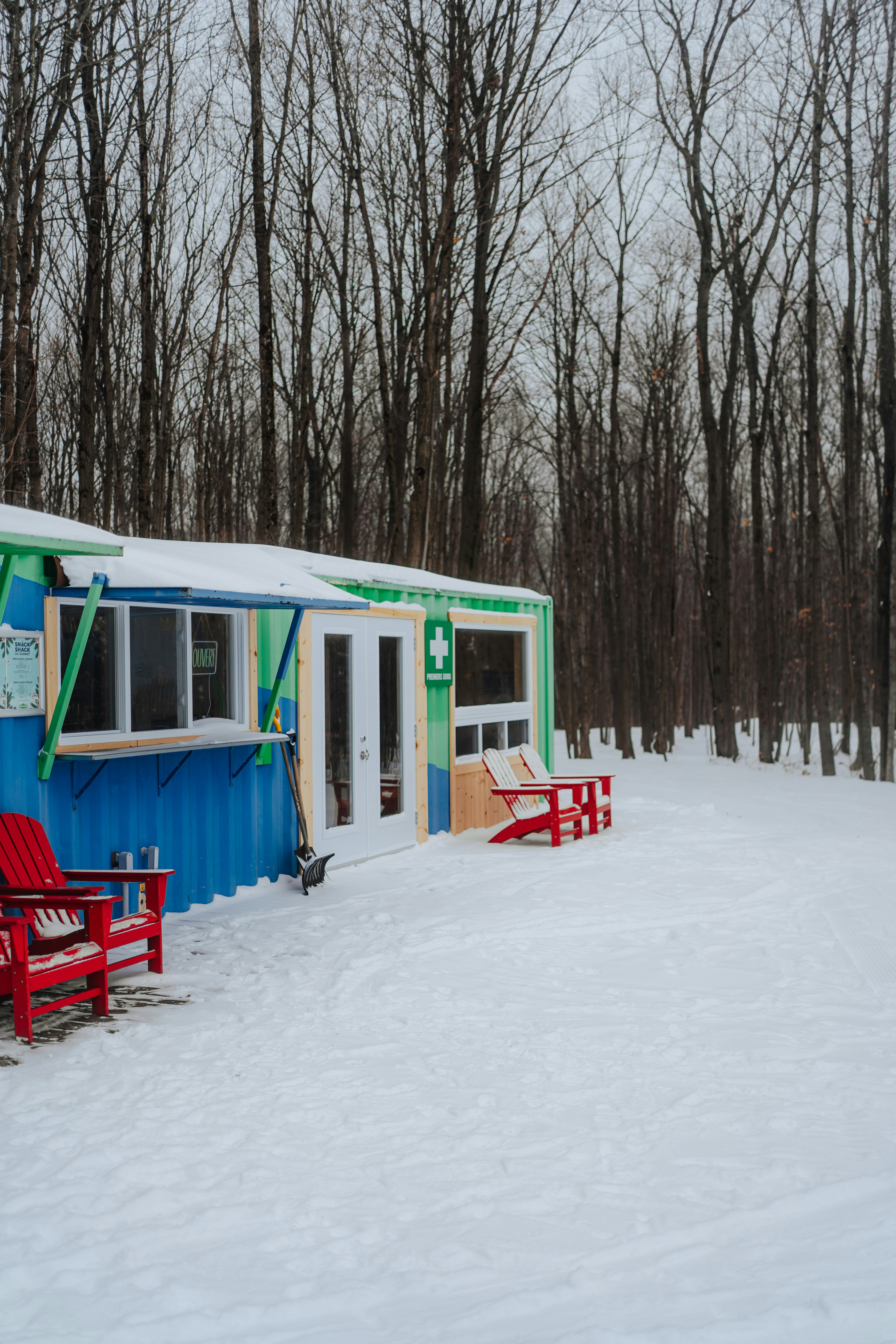 Snowy roadside café: Colorful huts in a quiet winter clearing