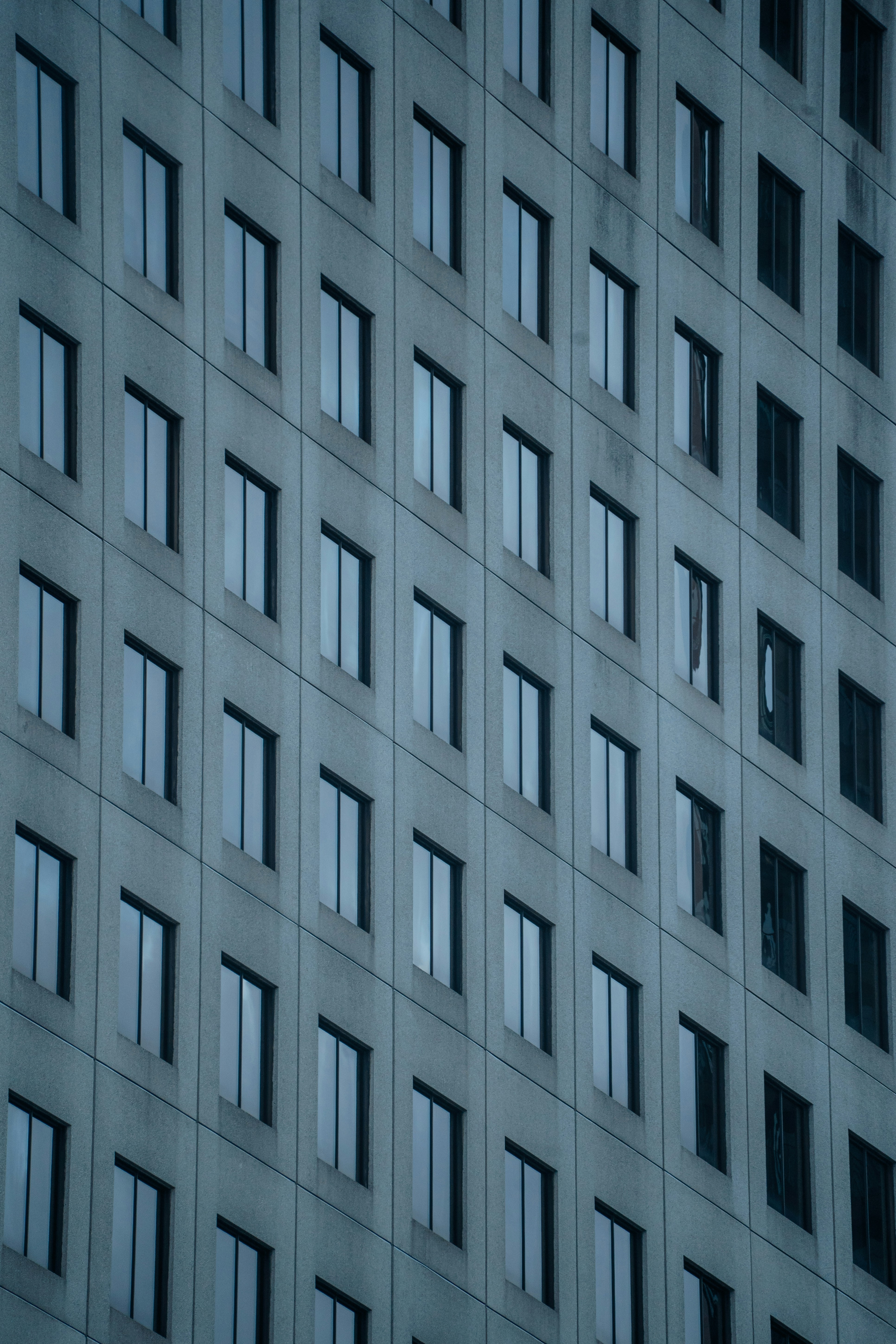 Diagonal Grid of Glass: A Distant Window Chorus on a Facade