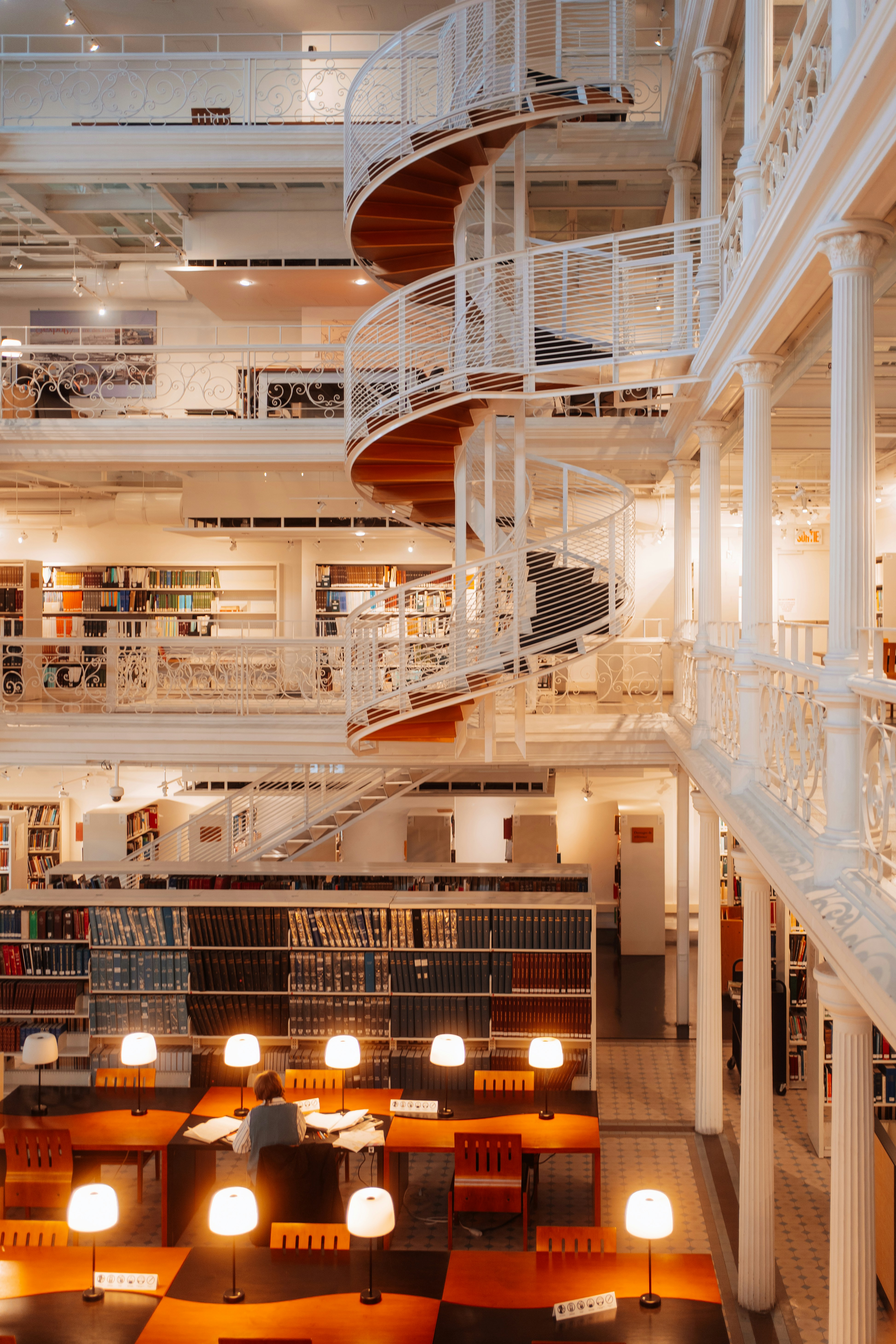 Spiral Staircase Through a Bright Library Atrium