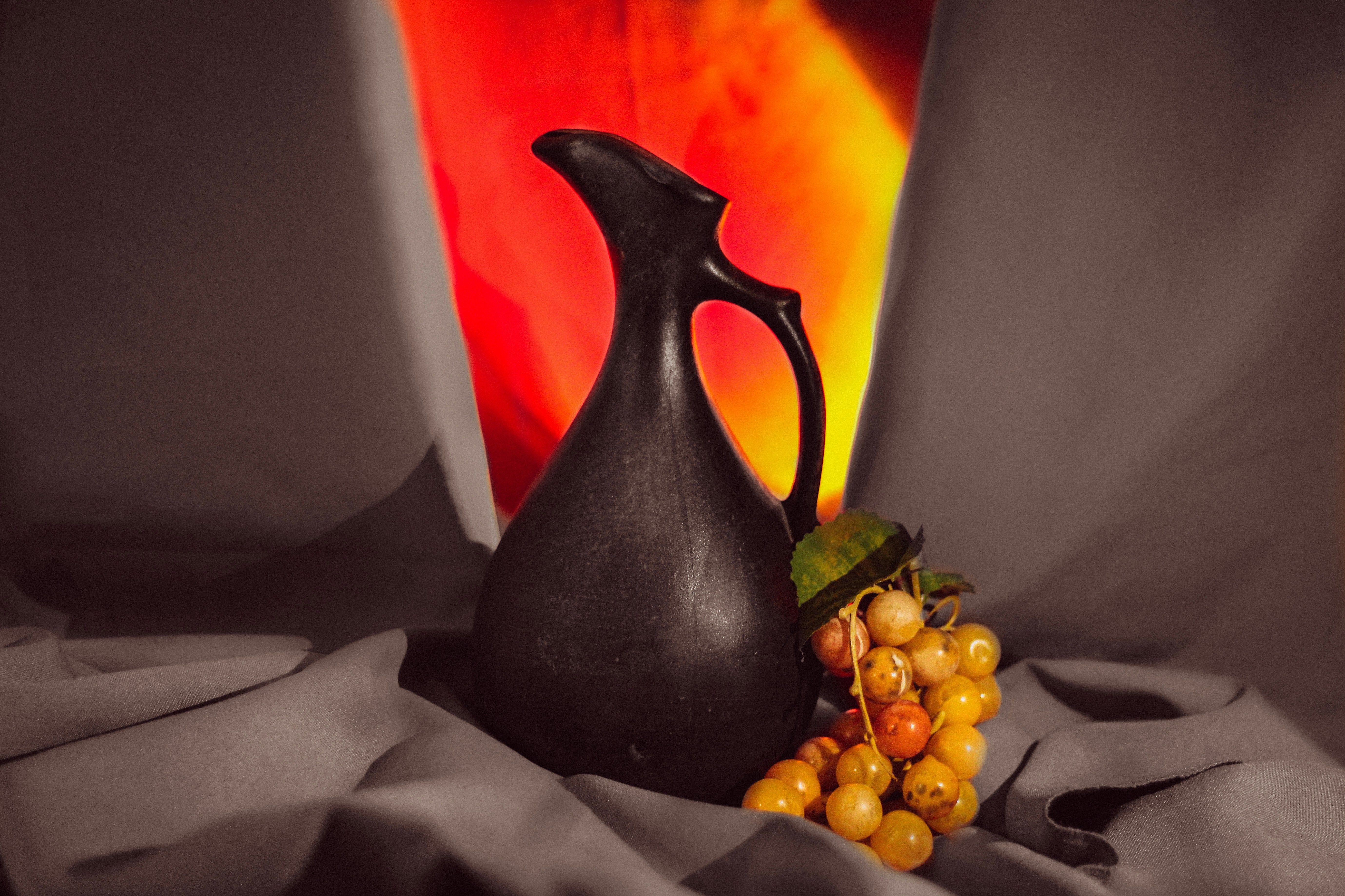 Dark Pitcher and Golden Bunch: A Quiet Still Life in Warm Light