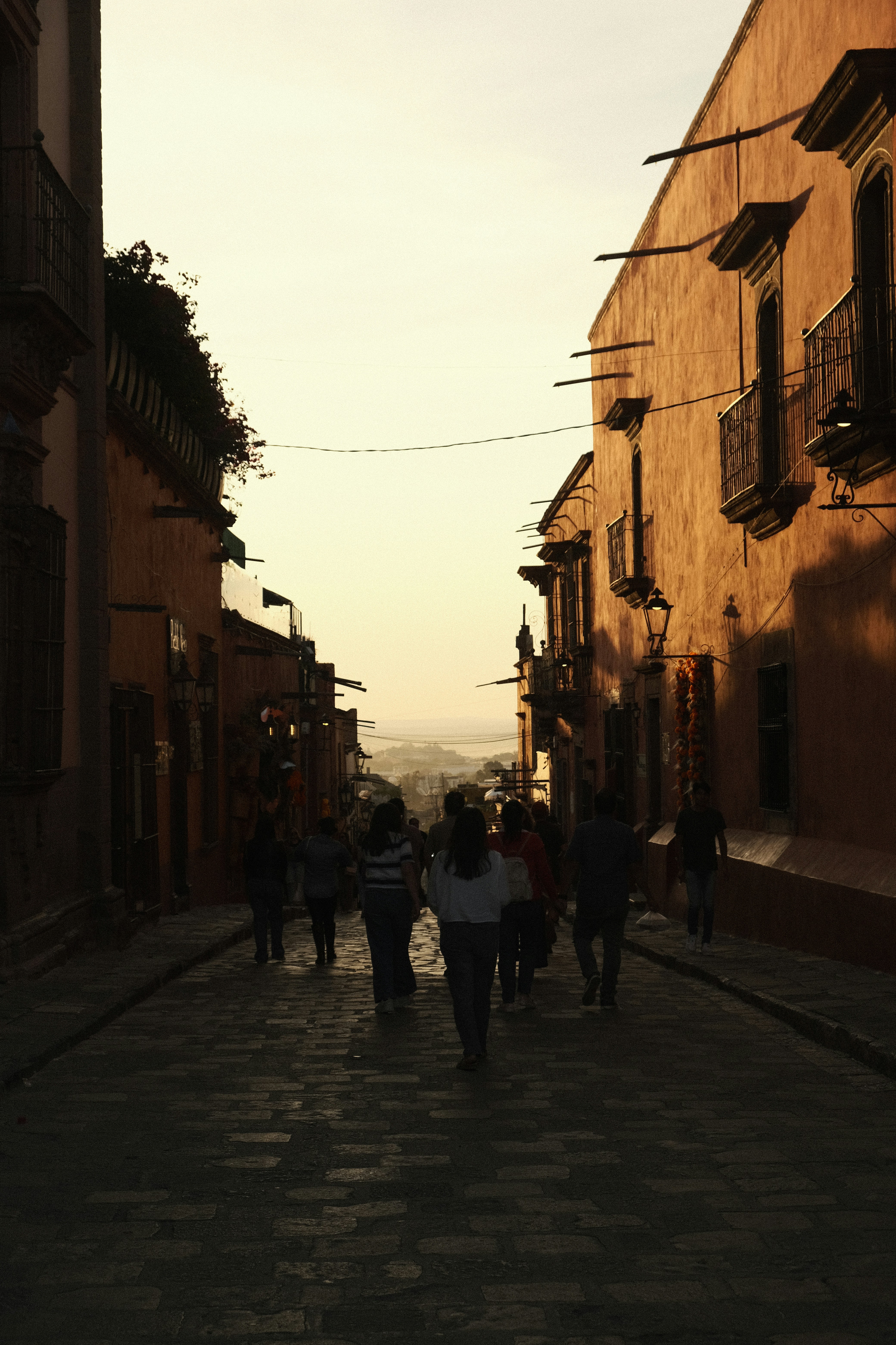 Sunlit Calle of Travelers