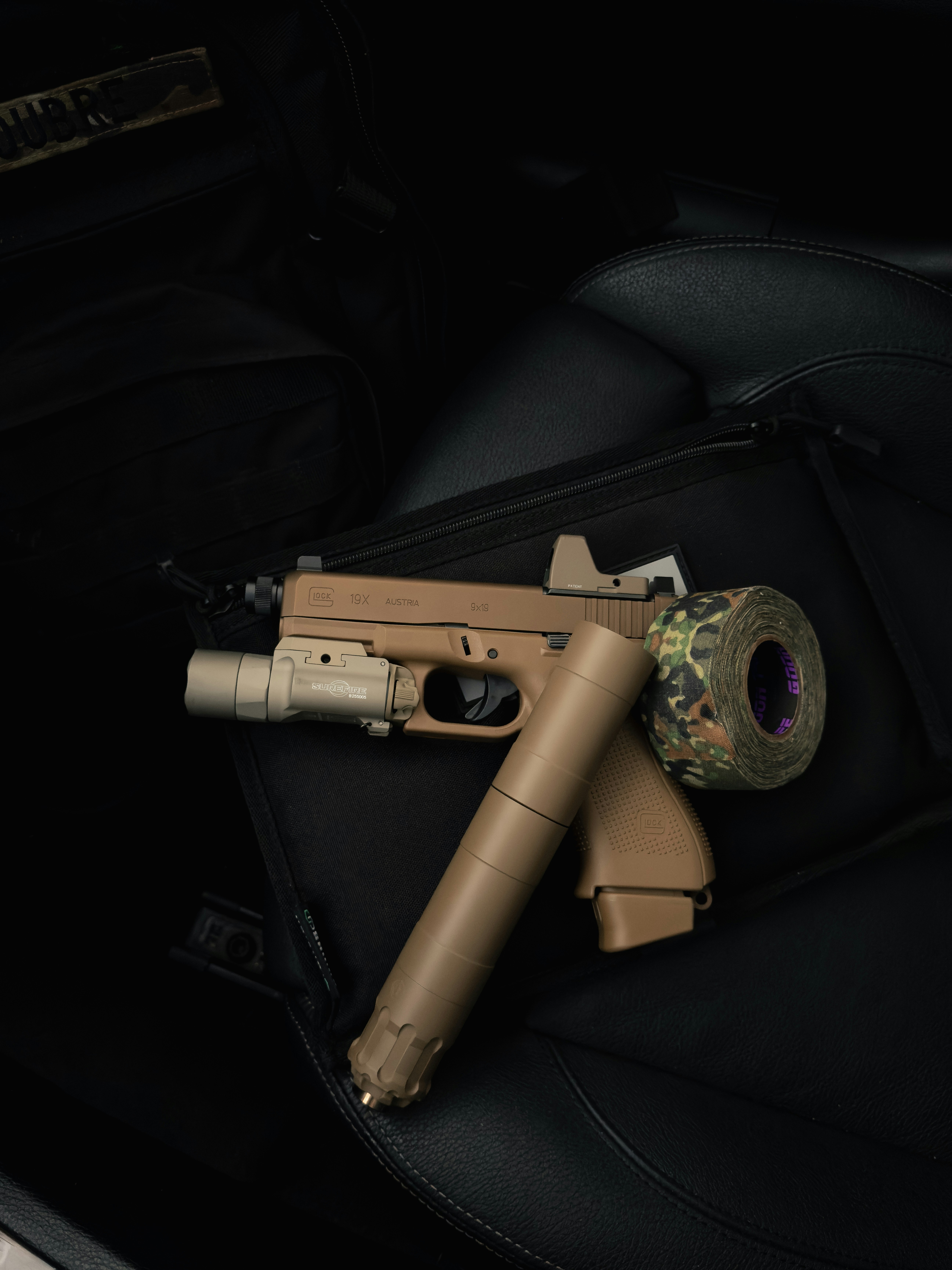 Desert Tan Assembly: A Tactical Handgun Set Resting in a Car Seat