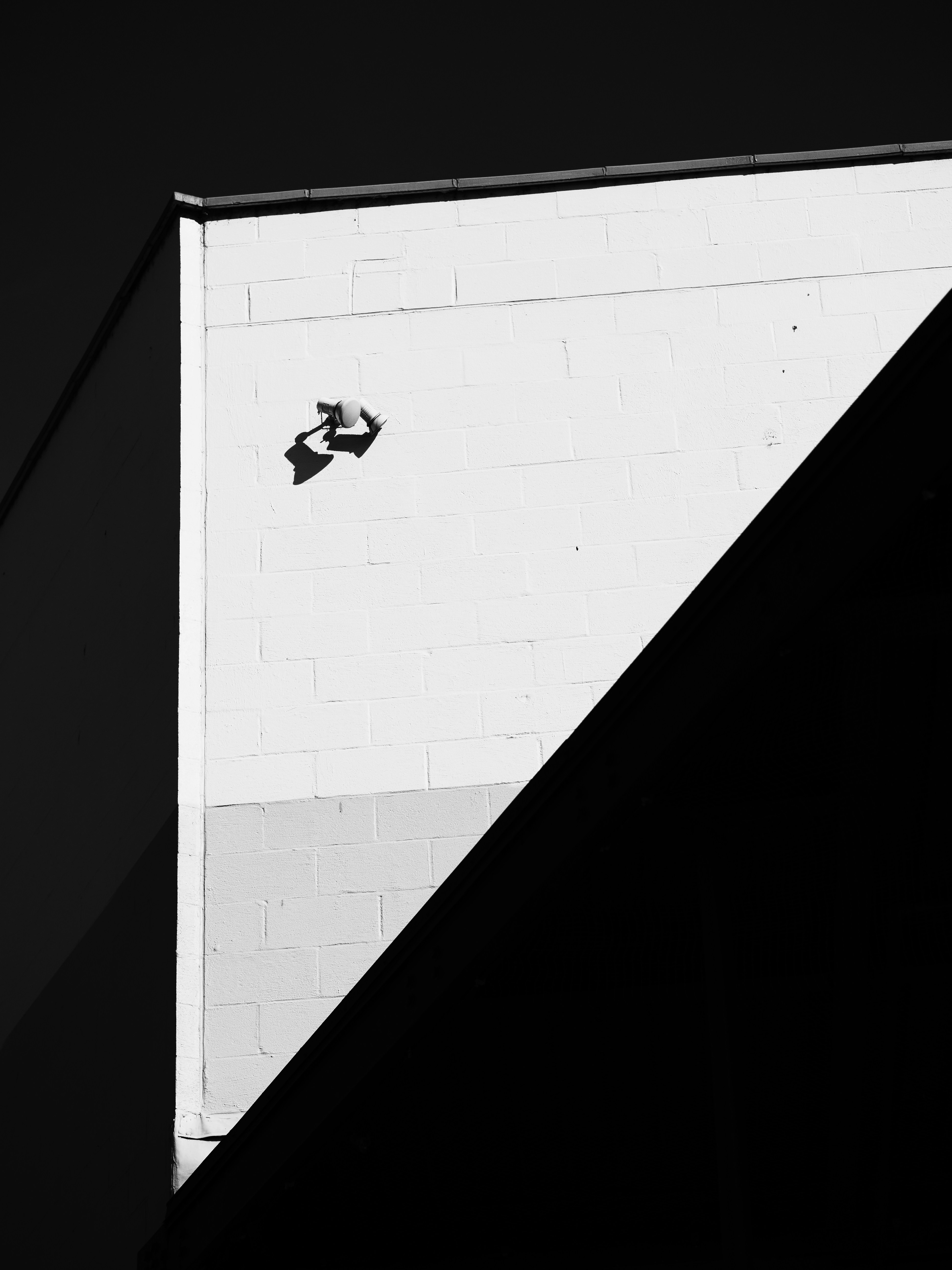 Shadowed Geometry: A Minimalist Corner of Light and Wall