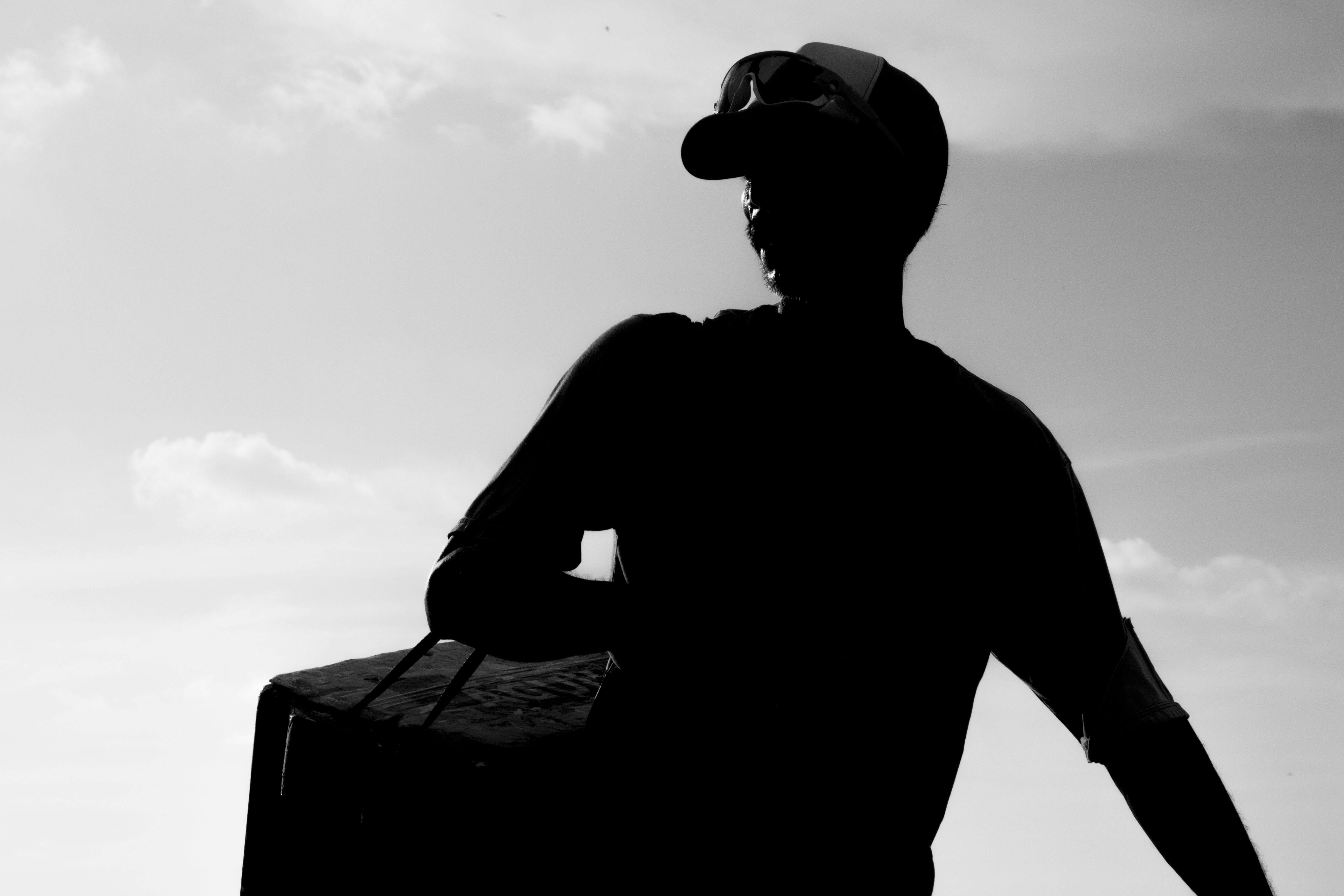 Silhouette in the Sunset: A Quiet Figure with a Surfboard