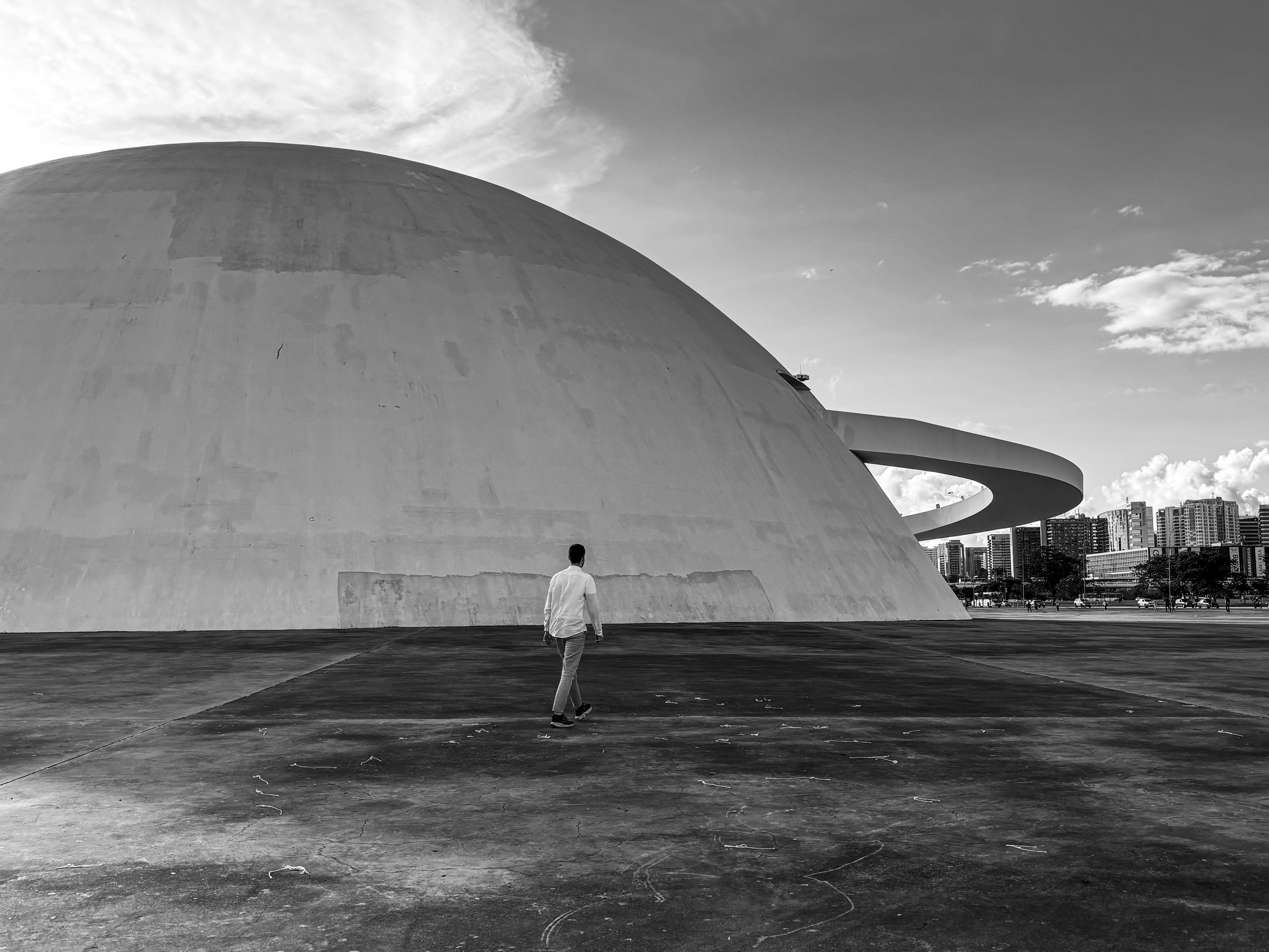  lone figure at the curved dome under sweeping sky