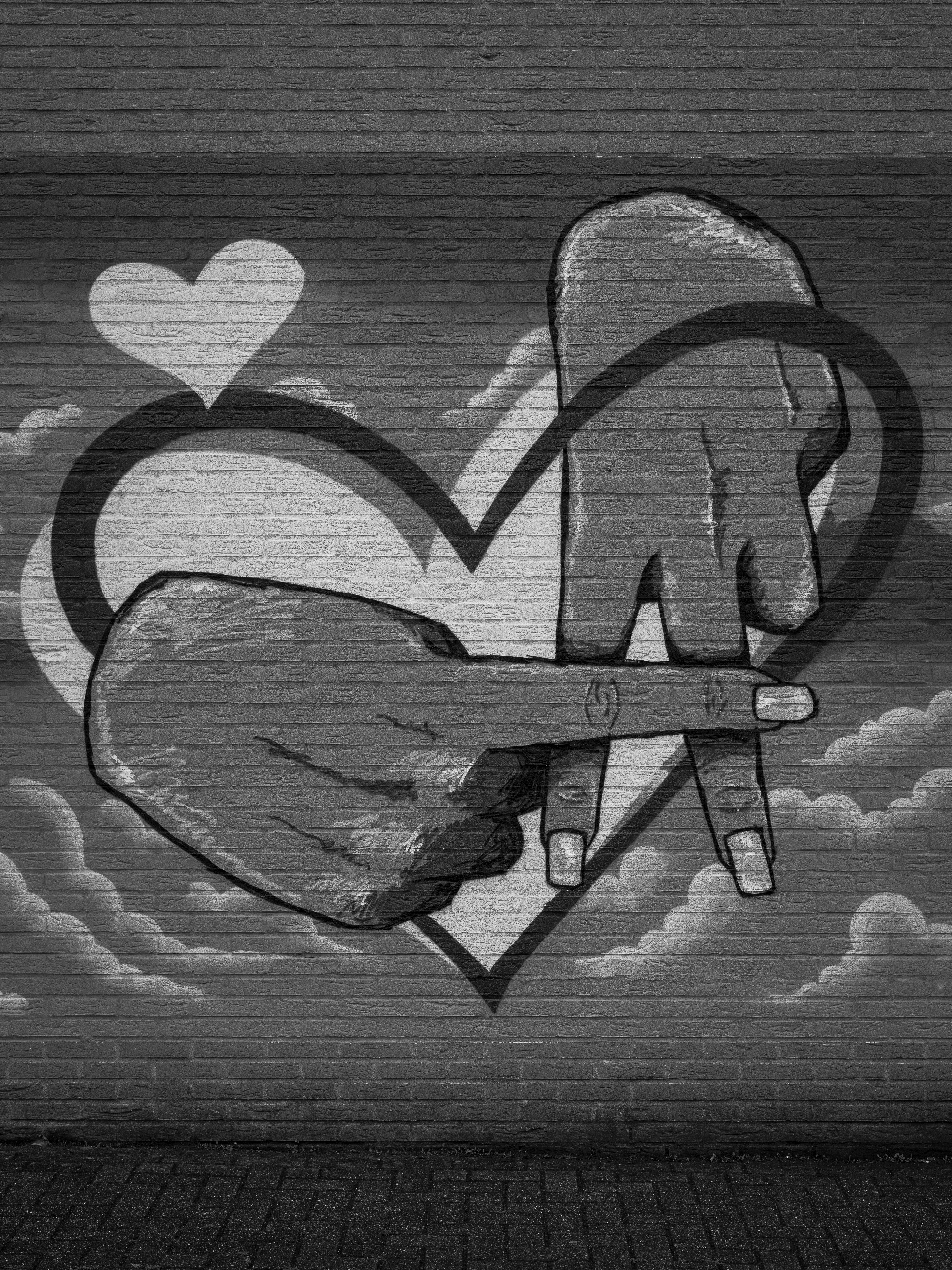 Heartbeat Graffiti: A Graffitied Hand Framing a Unity Sign