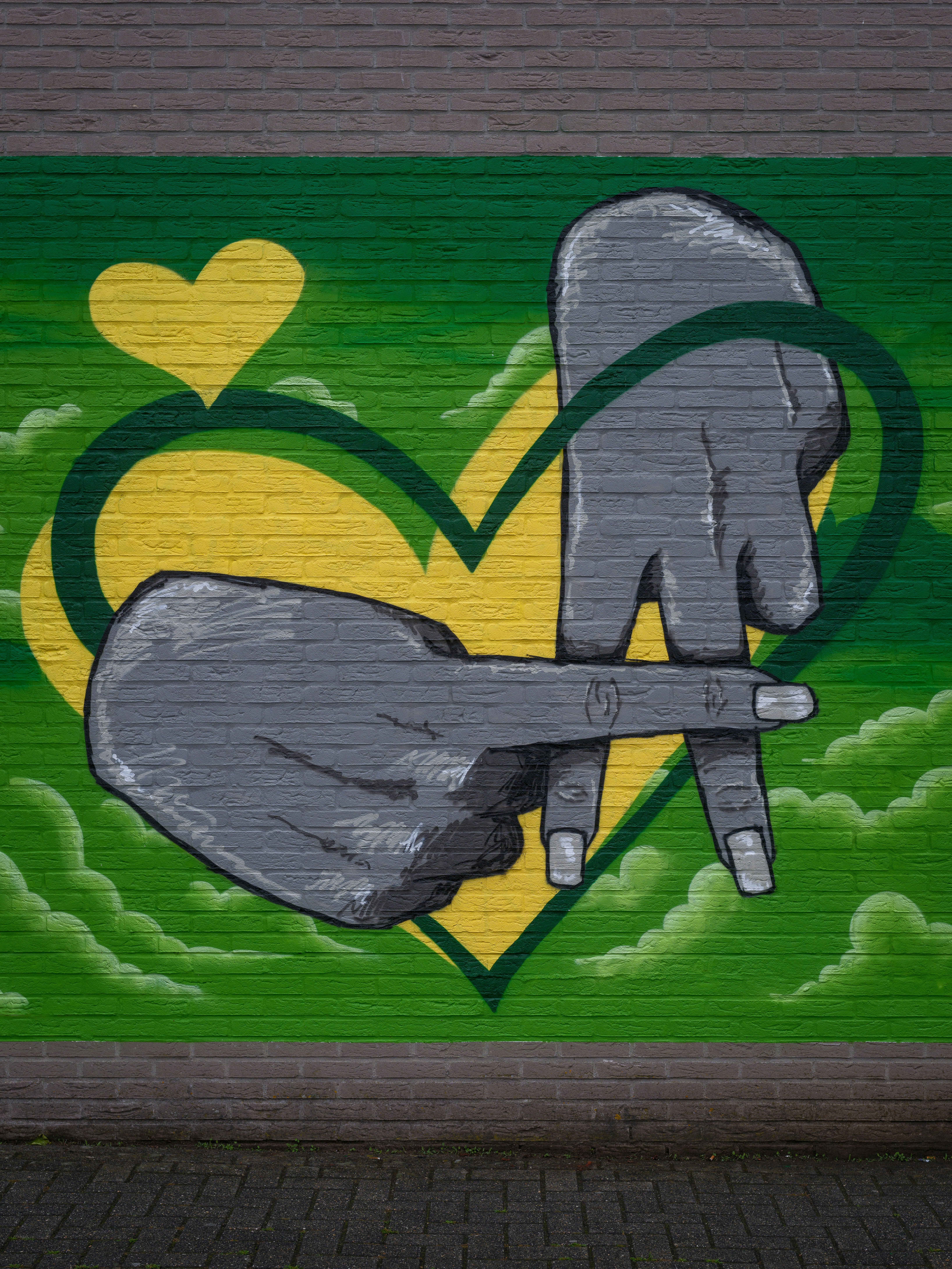 Graffiti Heart and Hand Grail: A Bold Gesture Across Brick