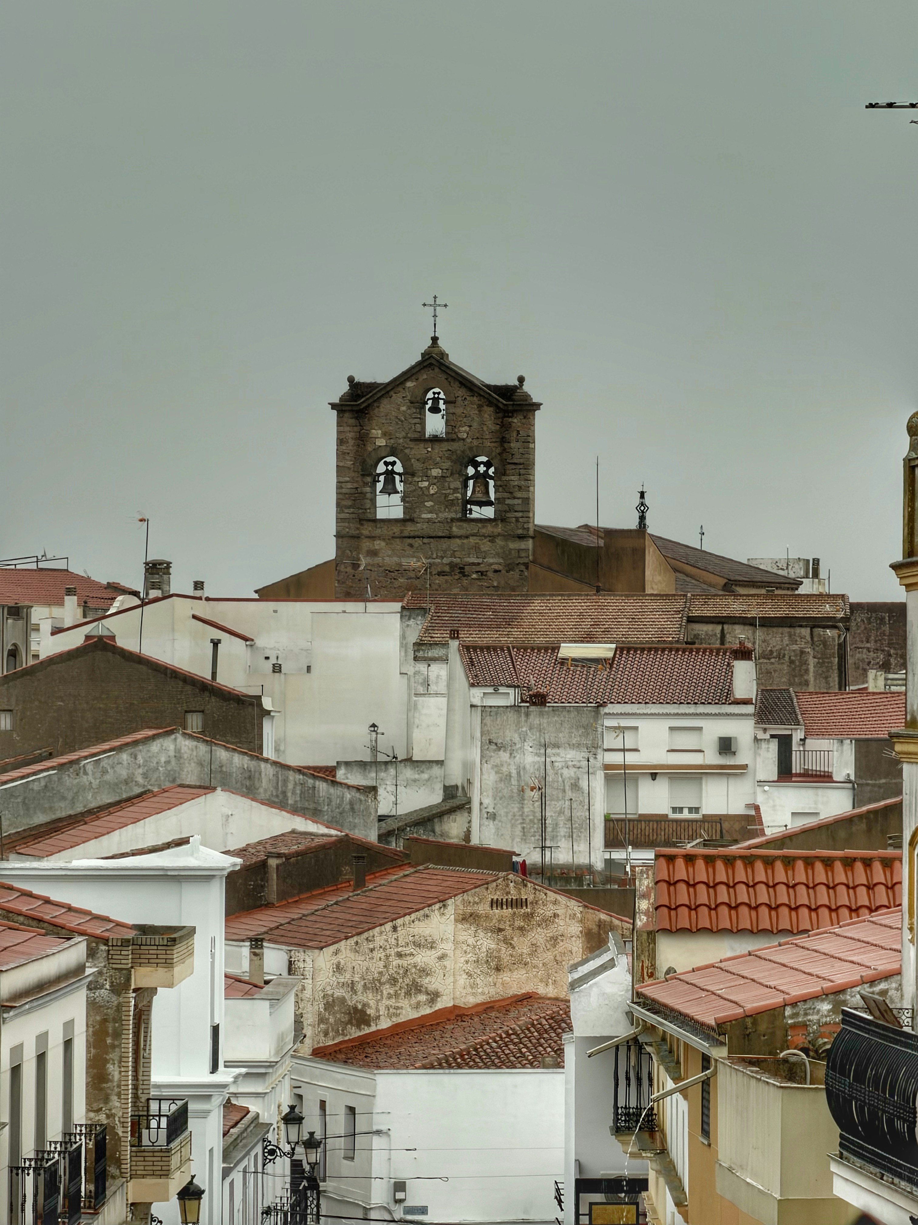 Hilltop Bell Tower Surrounded by Warm-Toned Mediterranean Rooftops