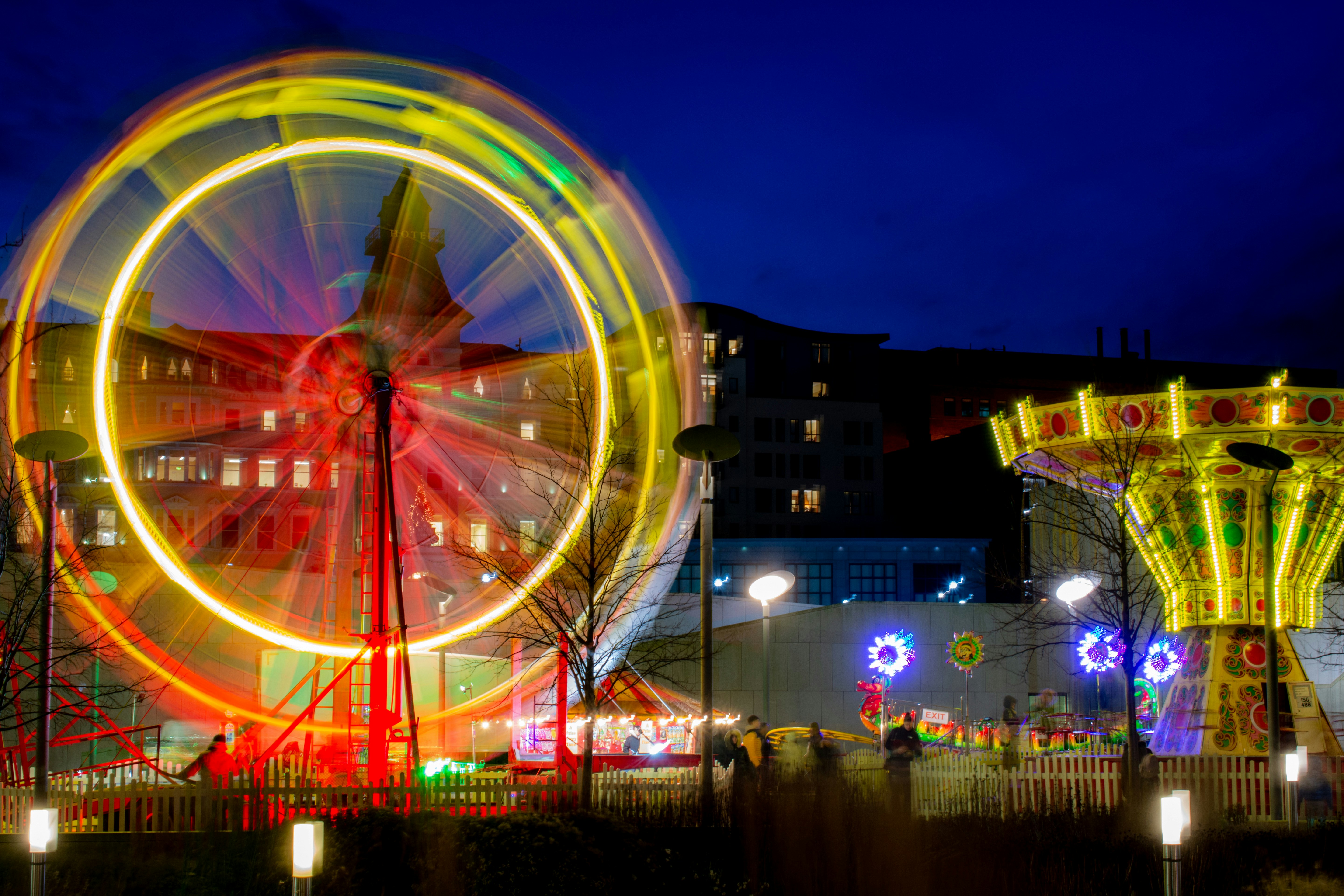 Neon Wheel in Motion: A Night at the Carnival