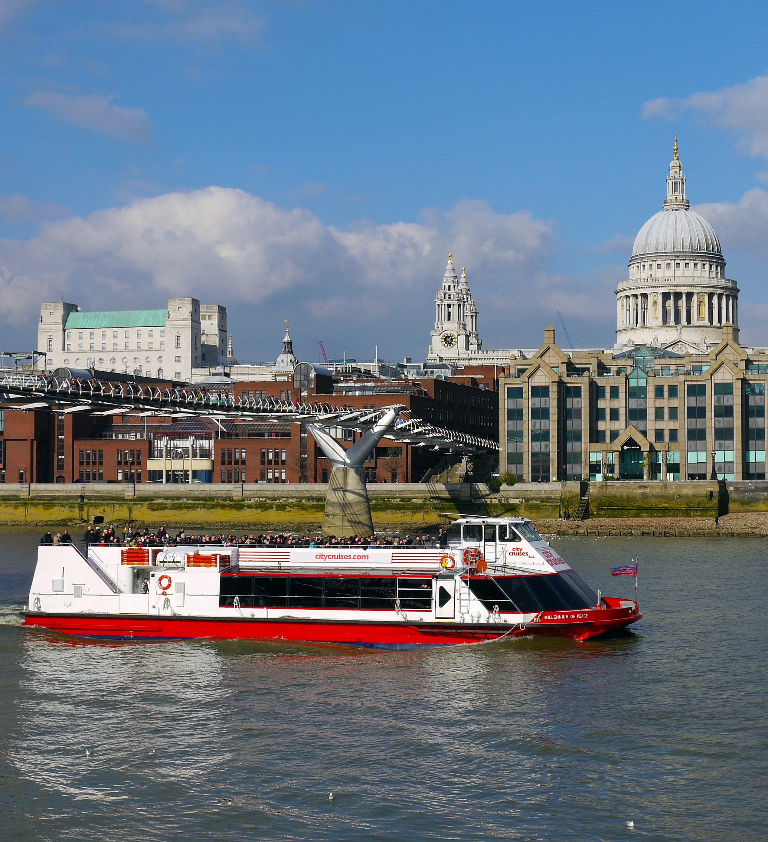 Cruise Ferry on River Thames in London, UK with St. Paul's Cathedral on background