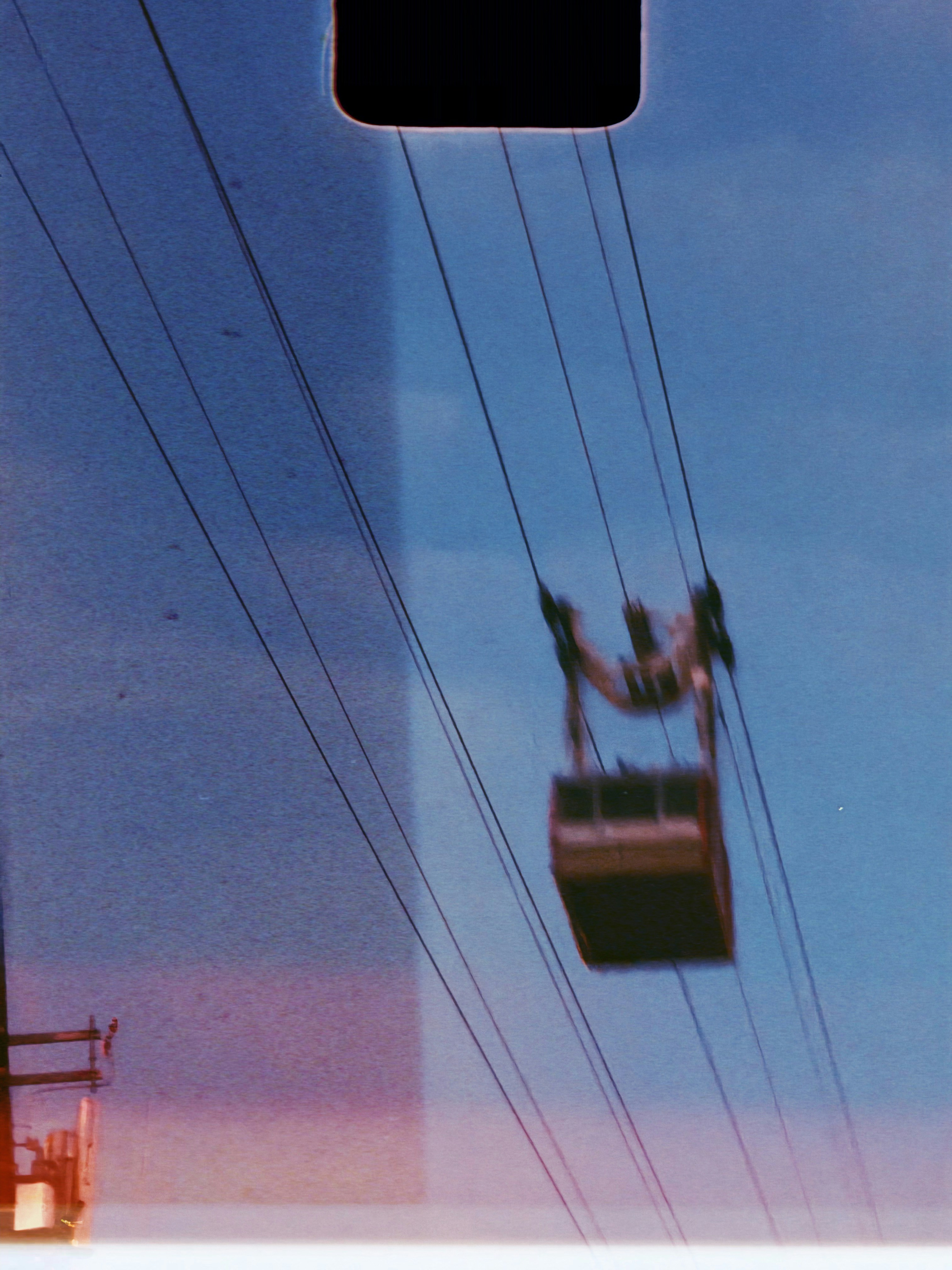 Cableway in Motion: A Tilted Ride Across a Saturated Skyline