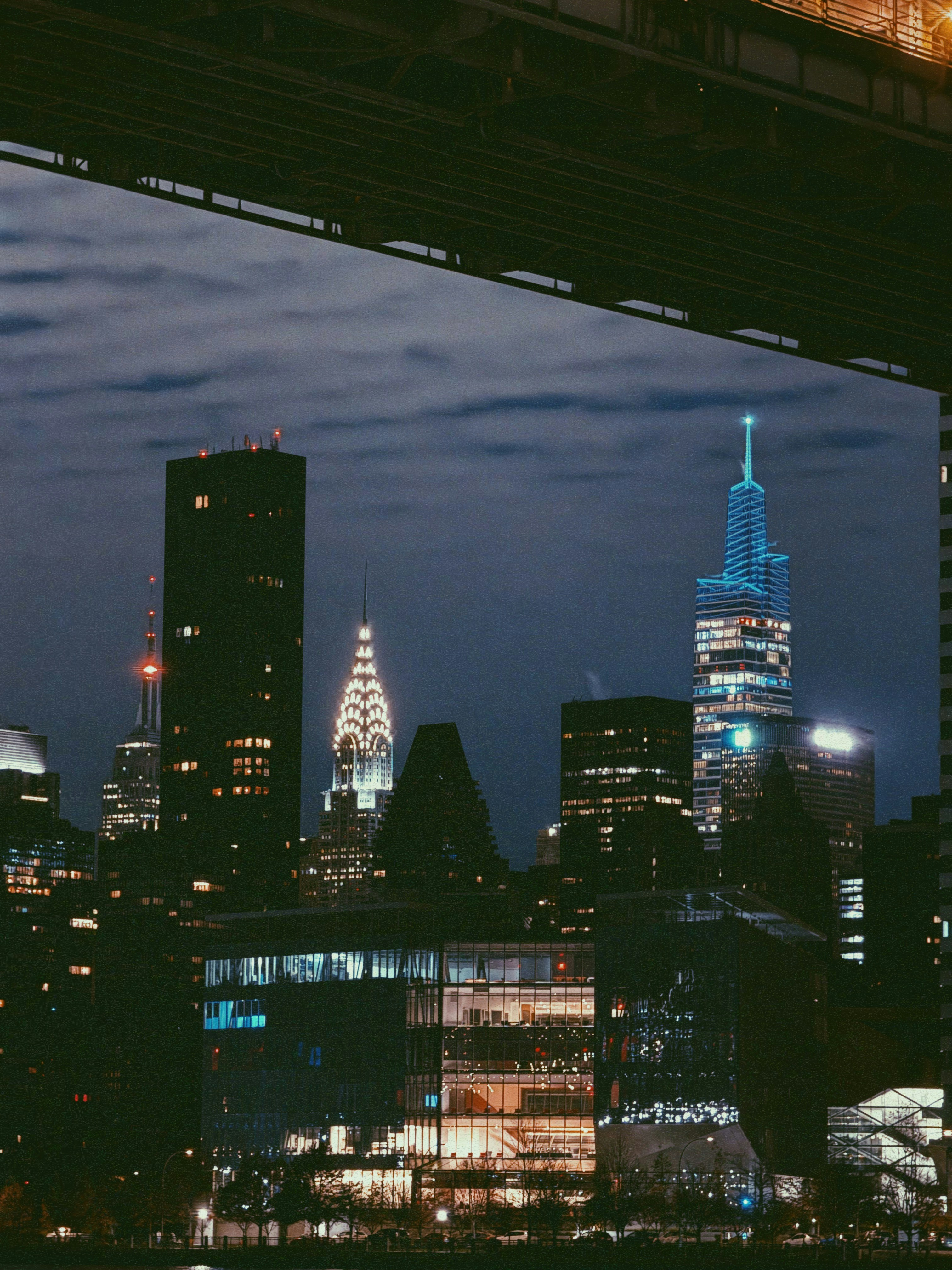 Night Skyline Under a Bridge: Neon Towers and Chrysanthemum Lights
