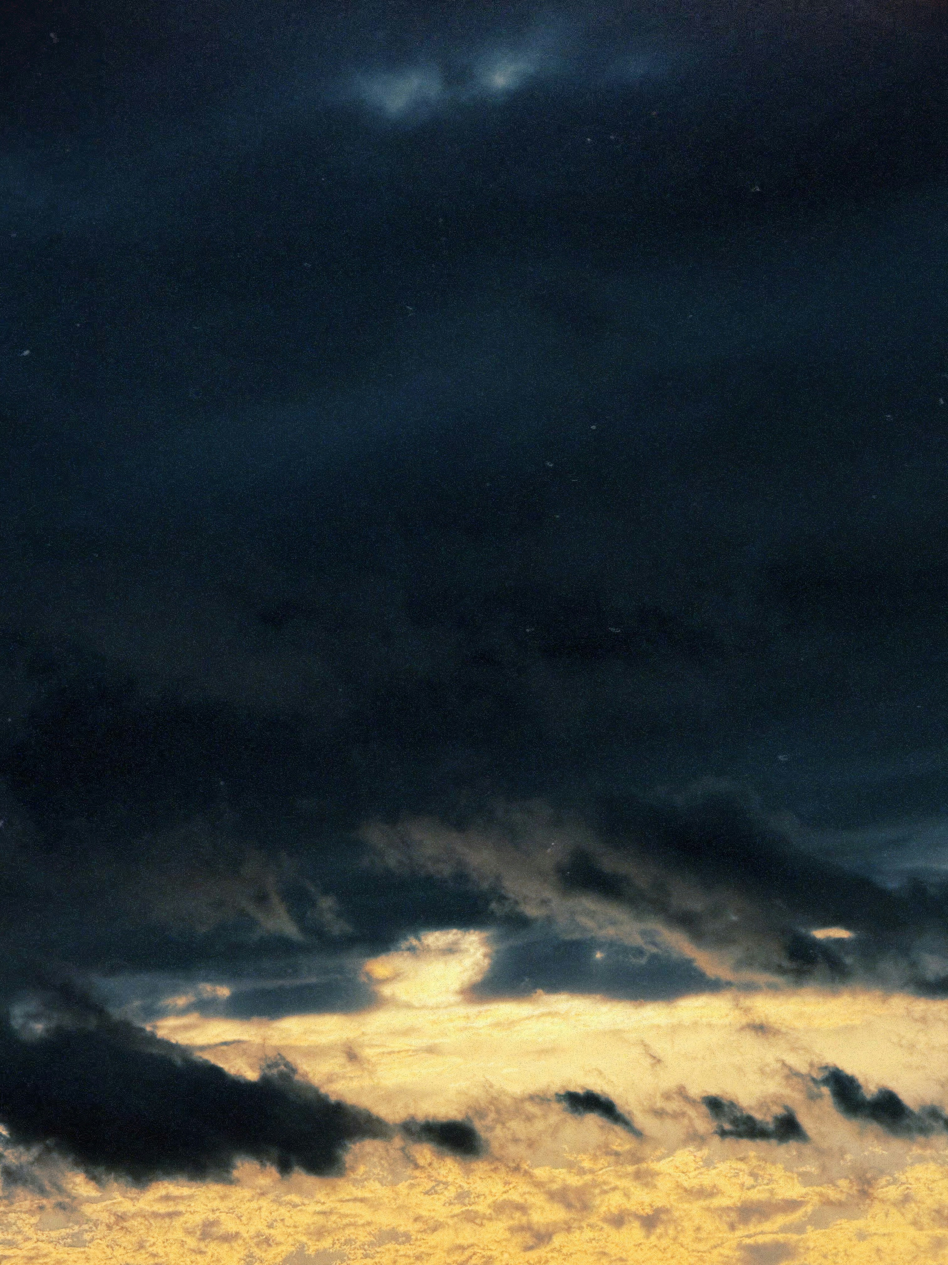 Dawn’s Edge: Gold Light Cutting Through Night Clouds