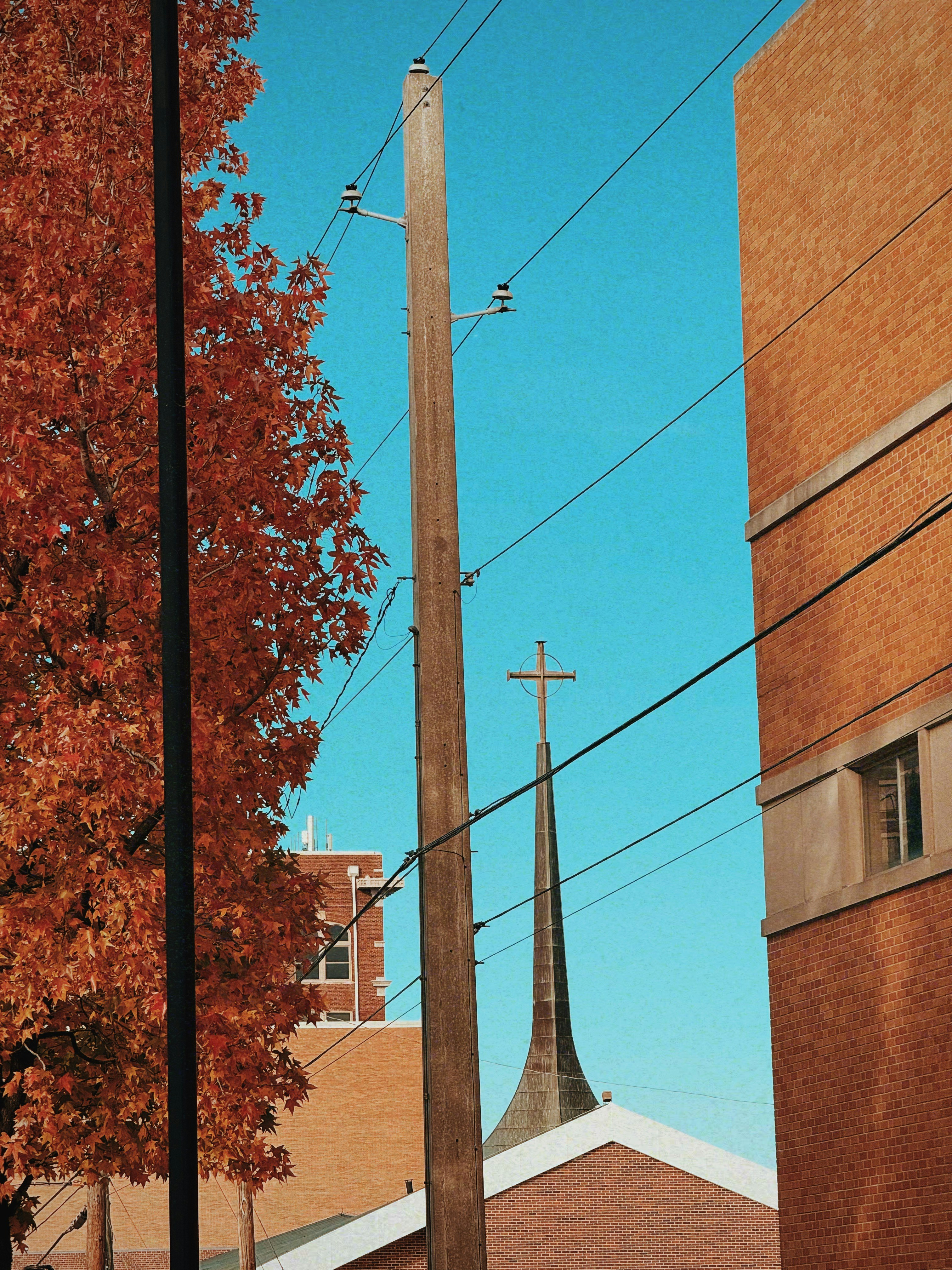 Crossing Lines Behind the Brick: A Quiet Urban Steeple