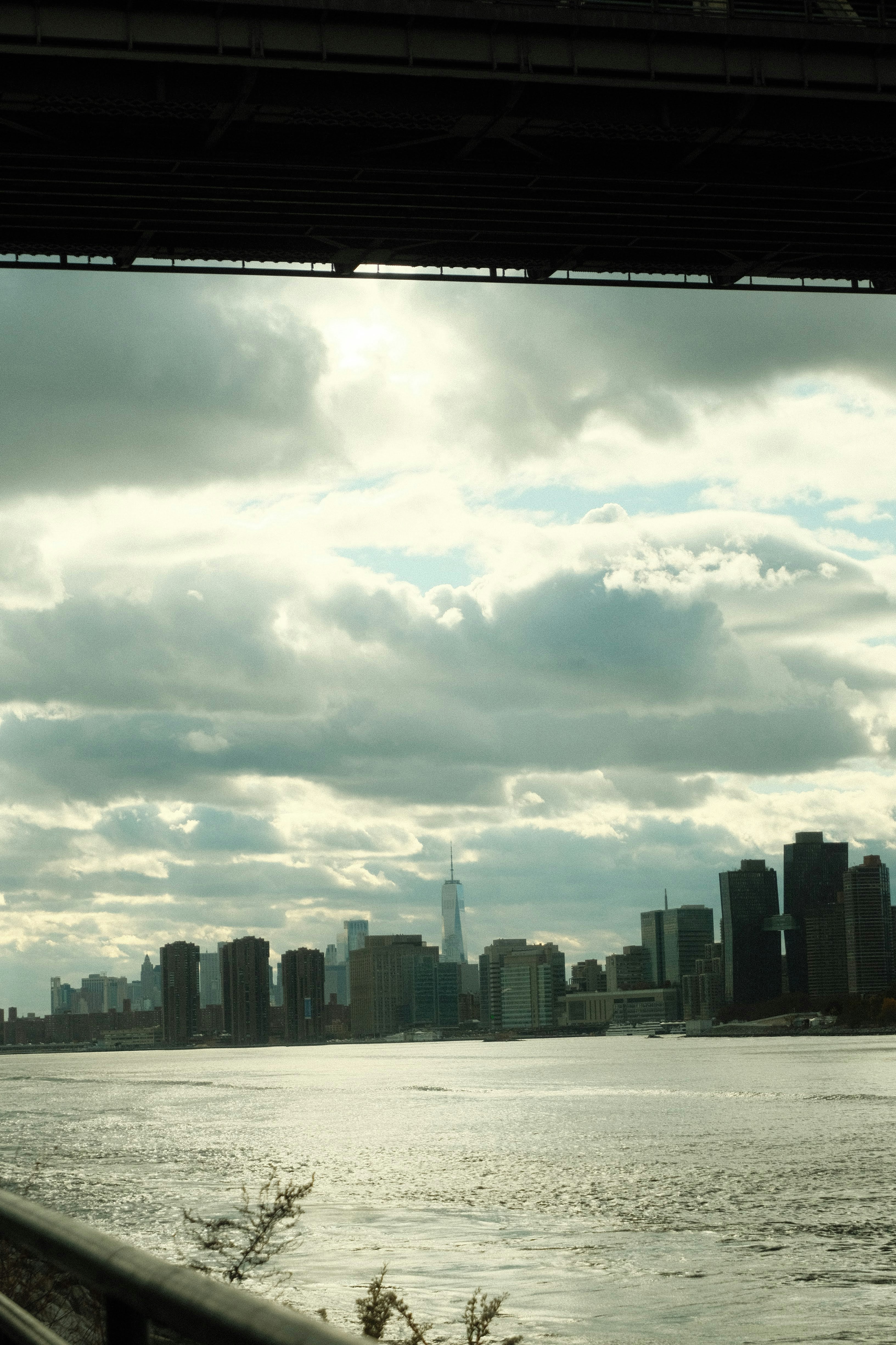 City Skyline Beneath a Framing Bridge