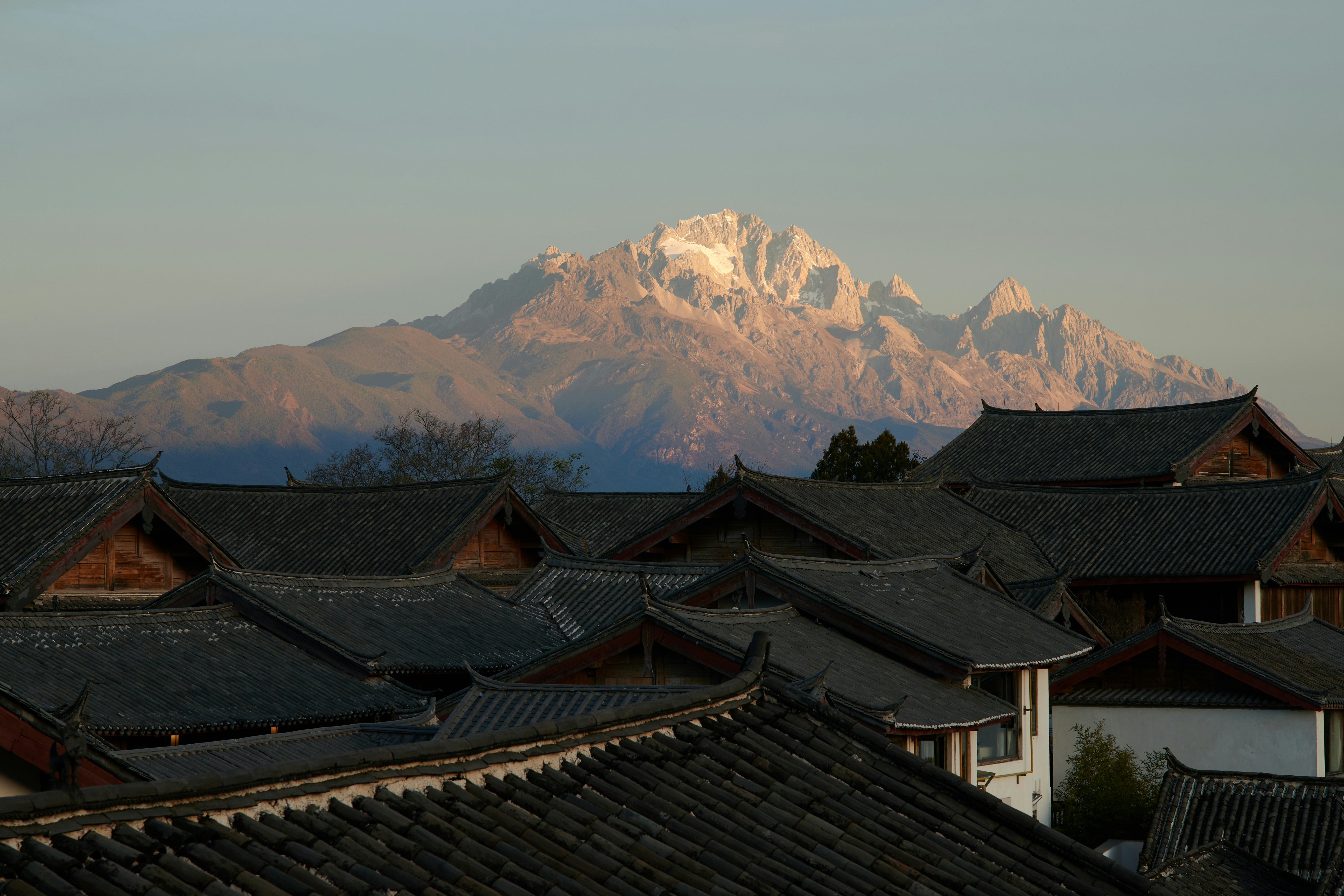 Snow-capped peaks over a quiet tiled village