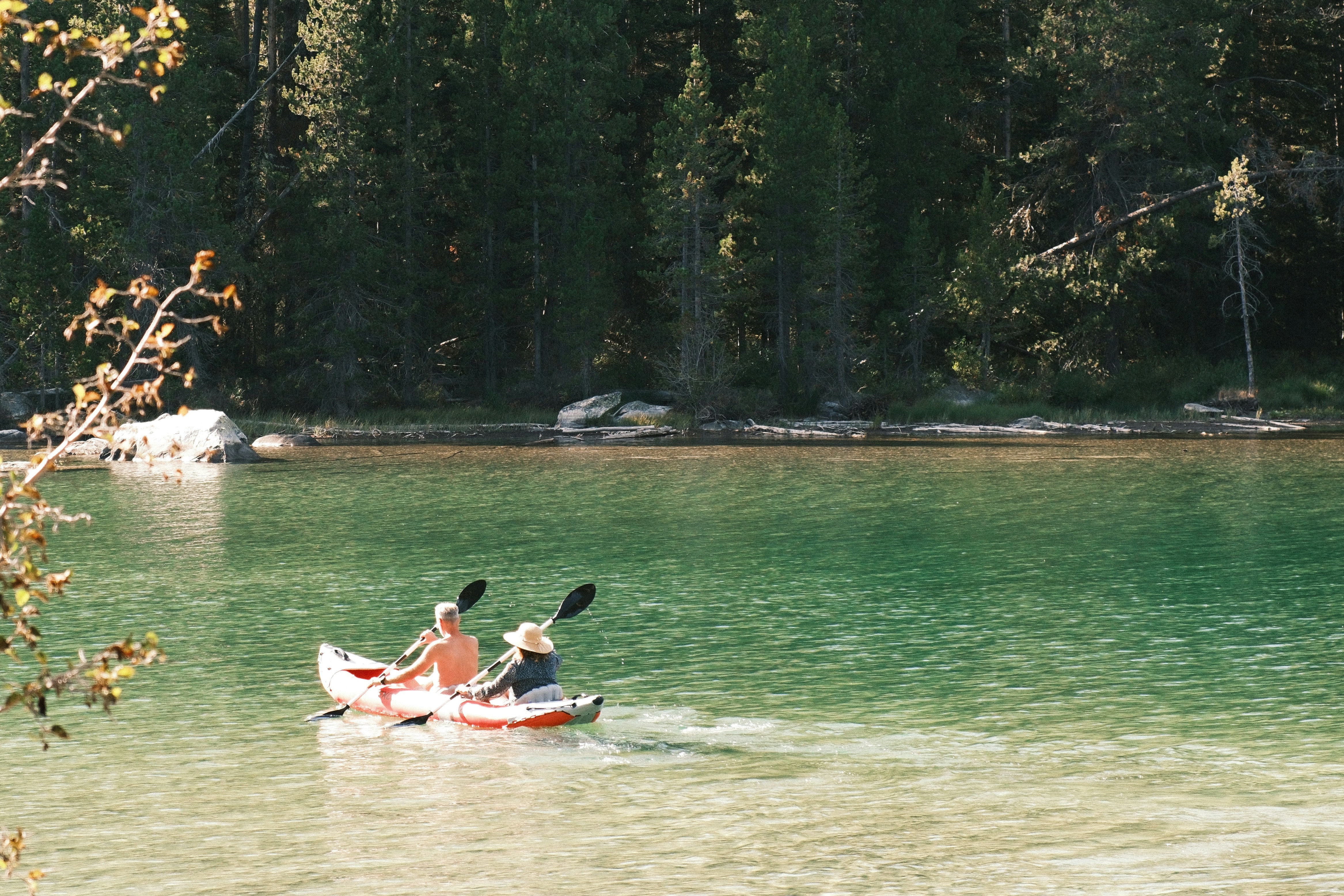 Two-Paddler Refuge: Sunlit Kayaks on a Calm Alpine Lake