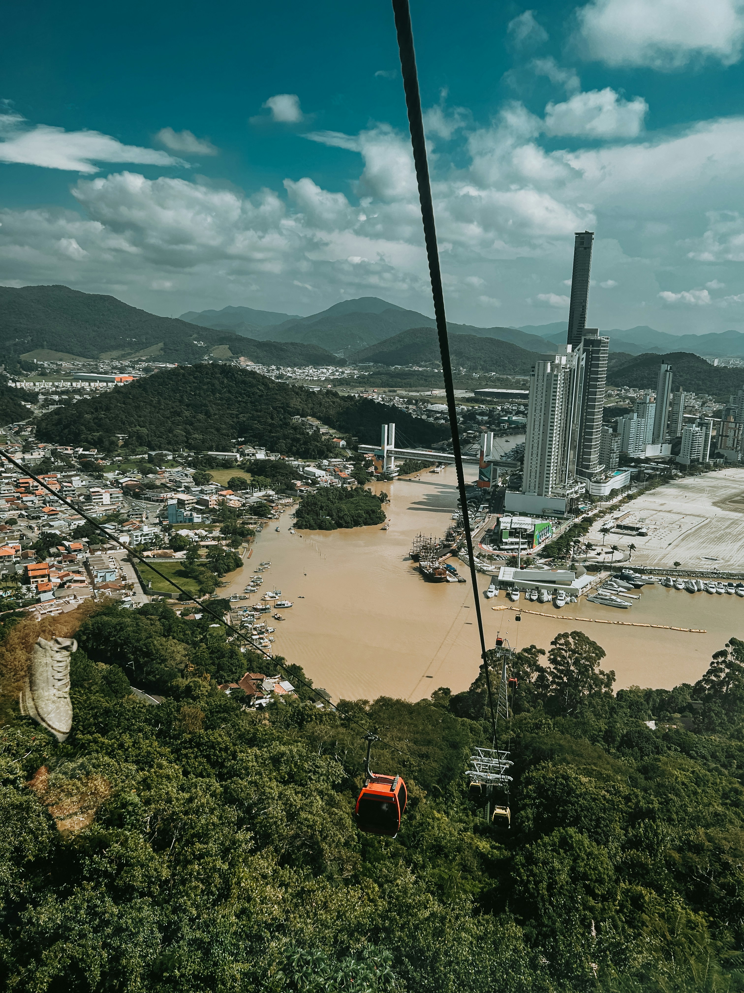 Cable Car Over a Coastal City: Aerial View from the Gondola