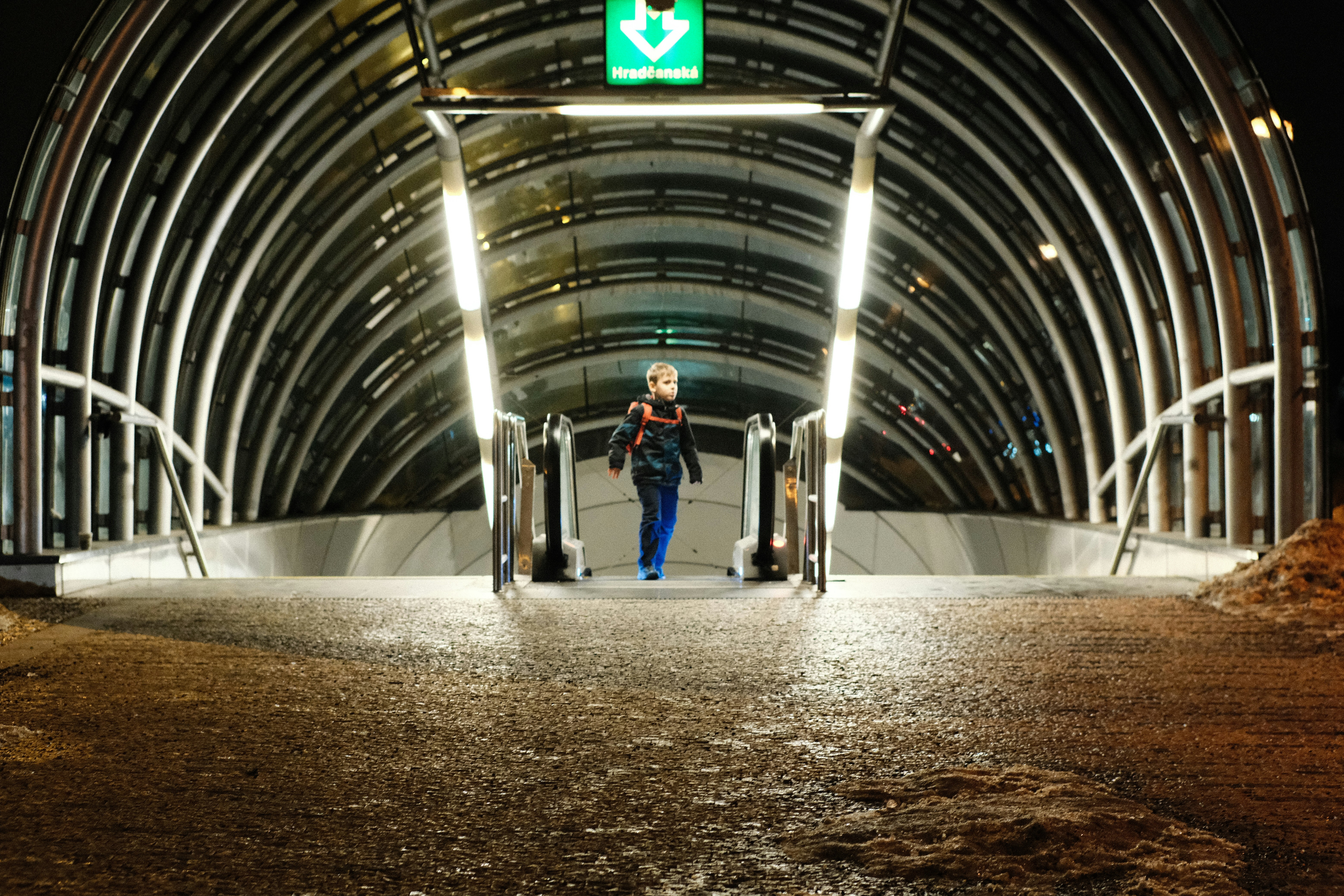 Traveler in a Neon Archway: Lone Figure Crossing the Tunnel