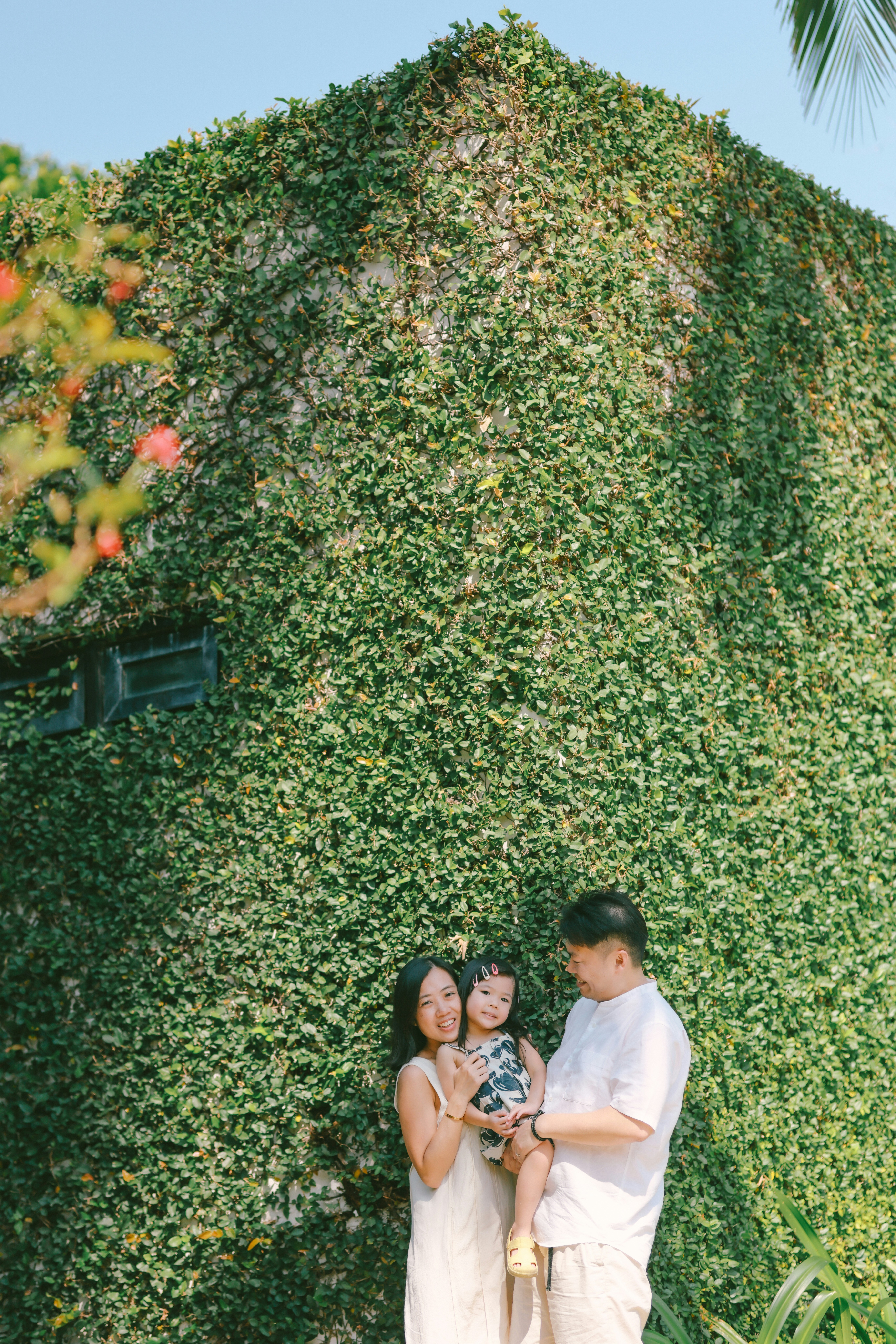 Family poses in front of a vine-covered wall photo – Free Family Image ...