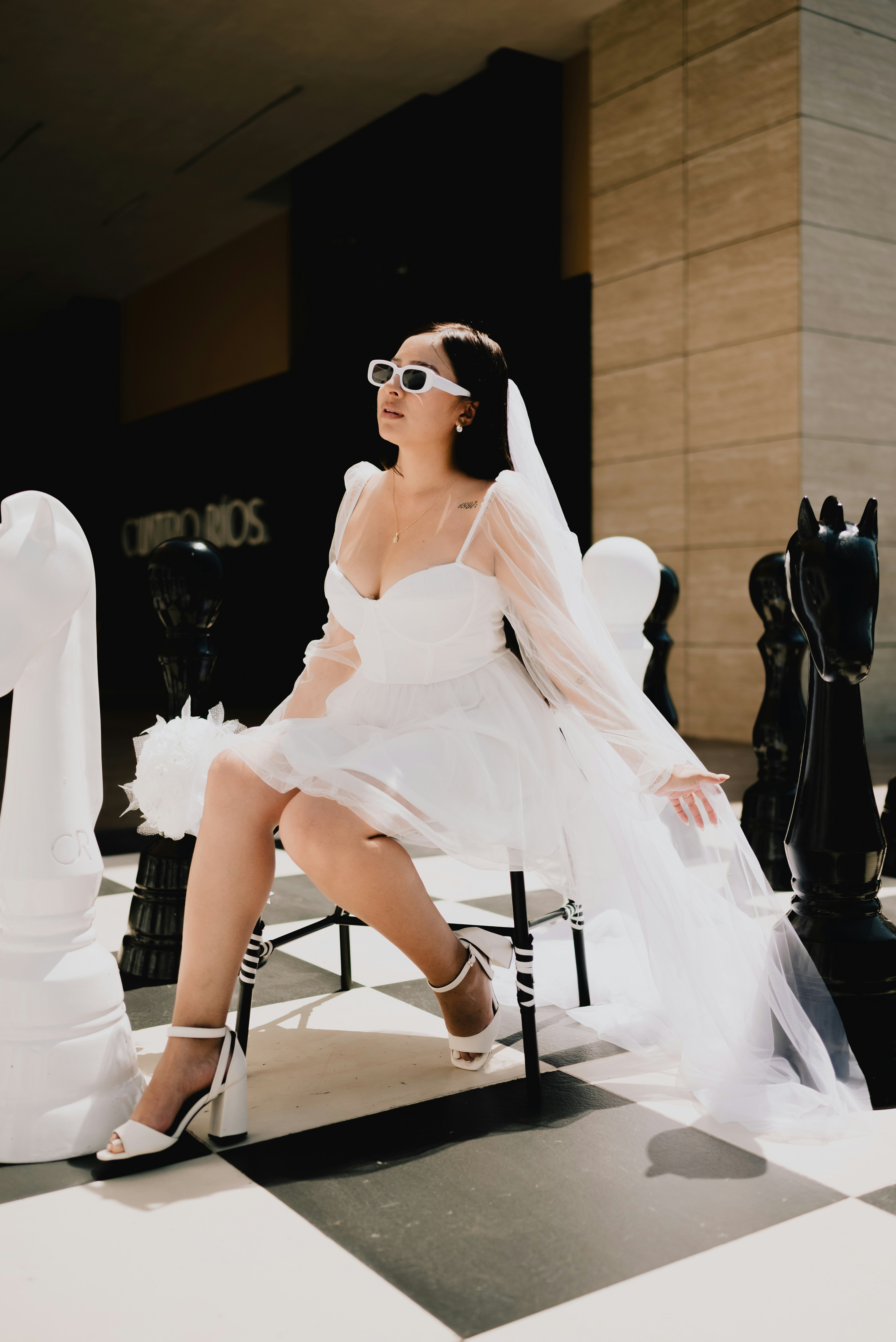White-Wedged Moment: Bridal Pose on a Chessboard Floor