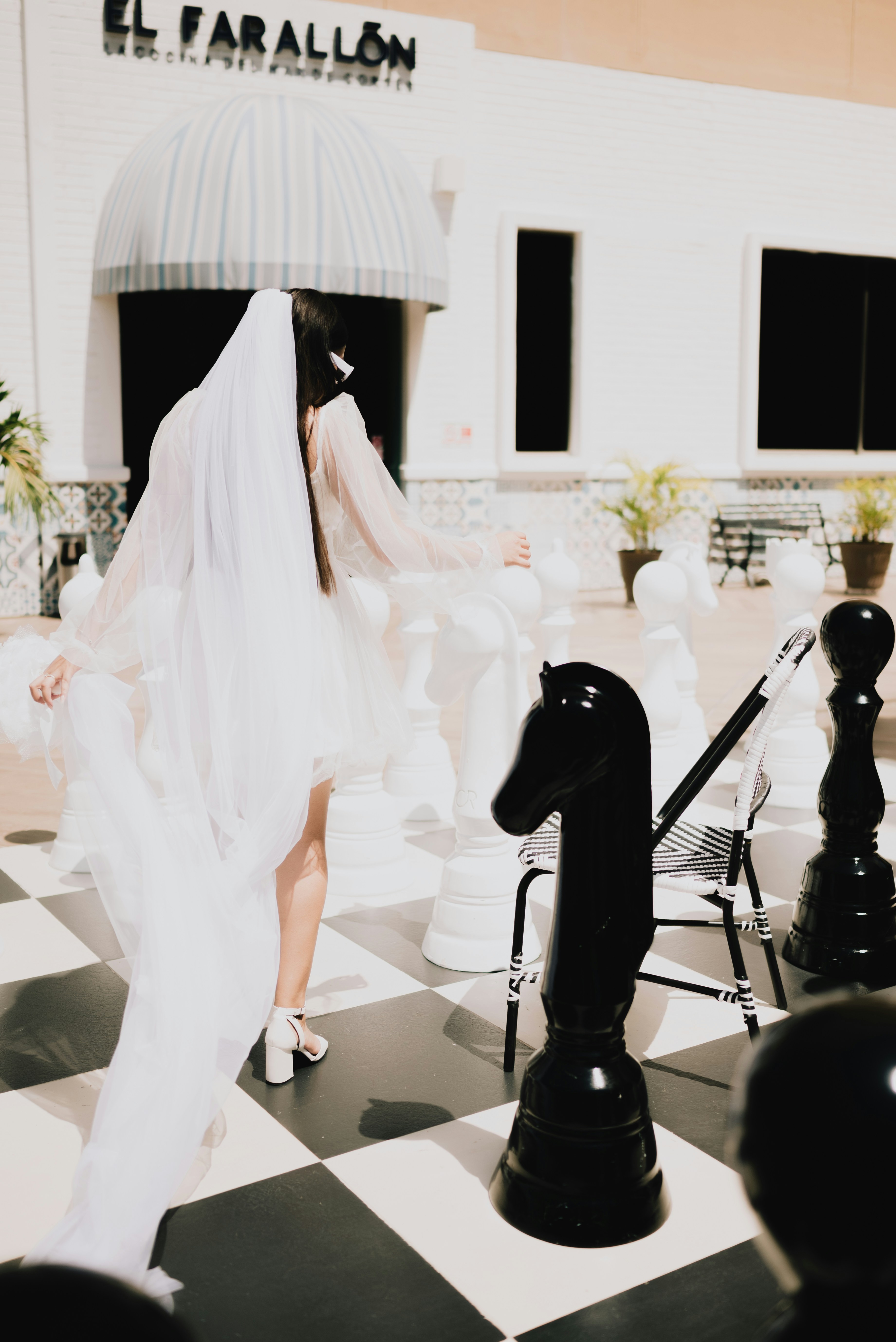 Bride in White Reaches for a Chessboard Moment