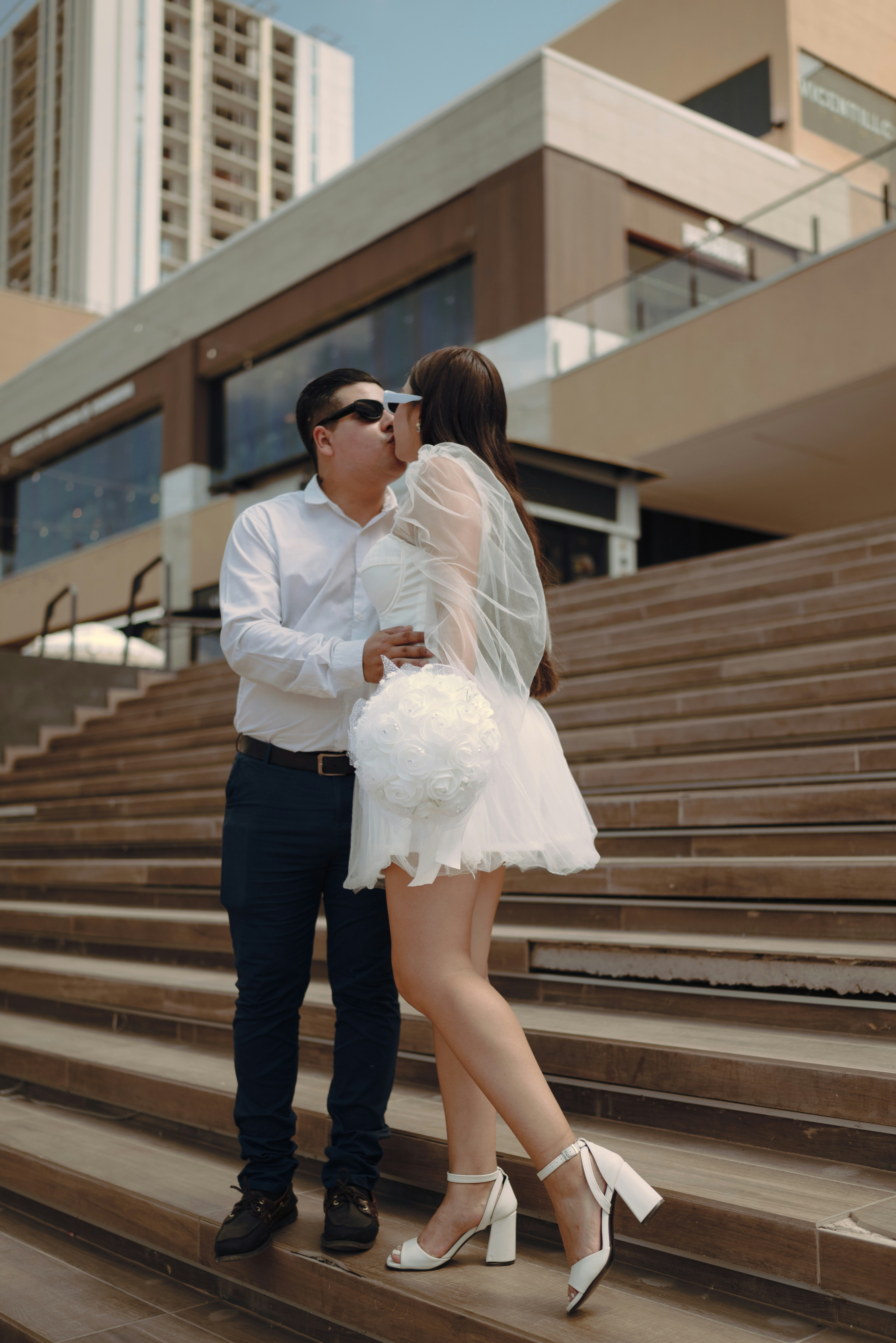 Kiss on the Urban Steps: A Bridal Moment in Modern Architecture