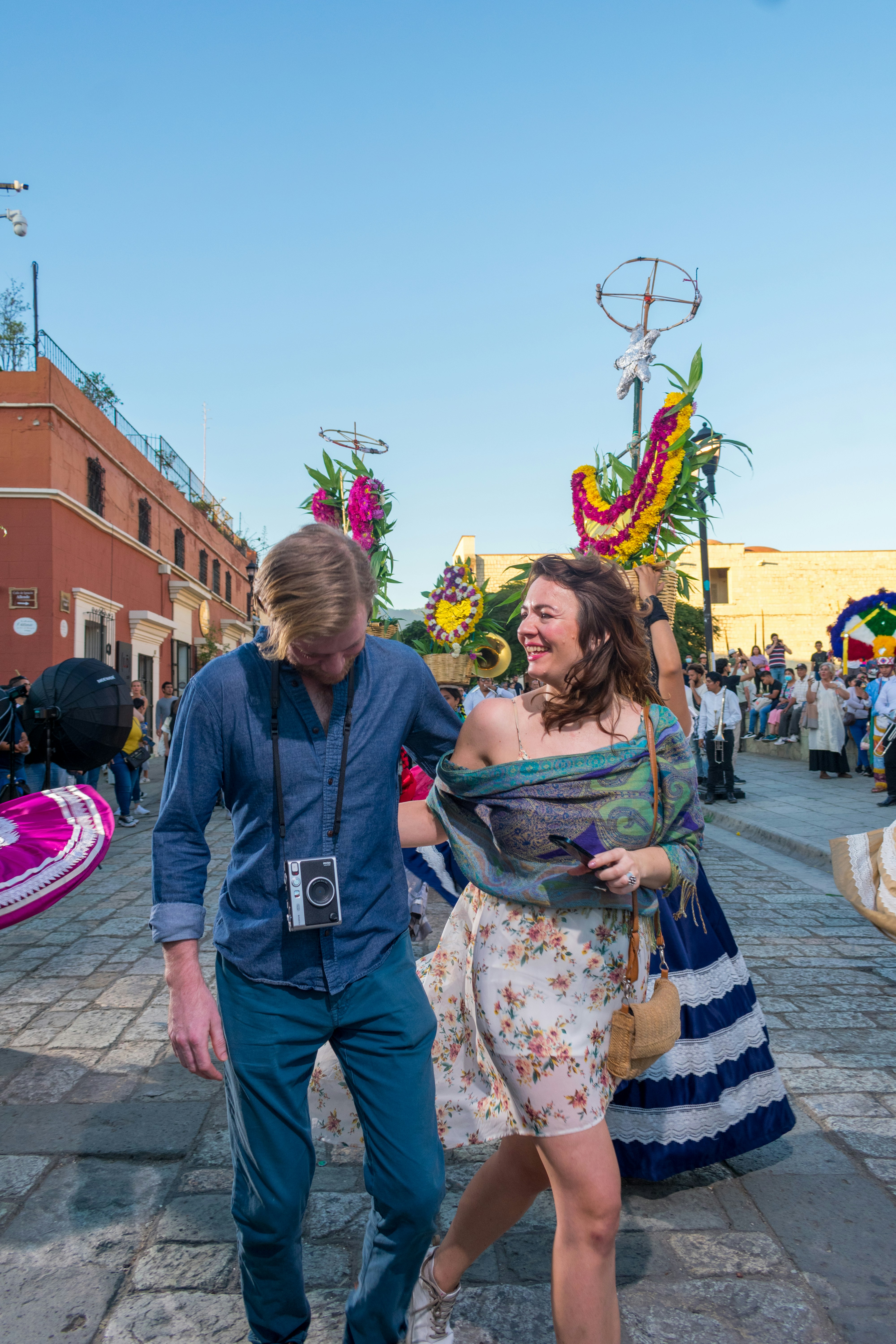 Street Festival: A Smiling Moment Between Travelist and Friend in Colorful Parade