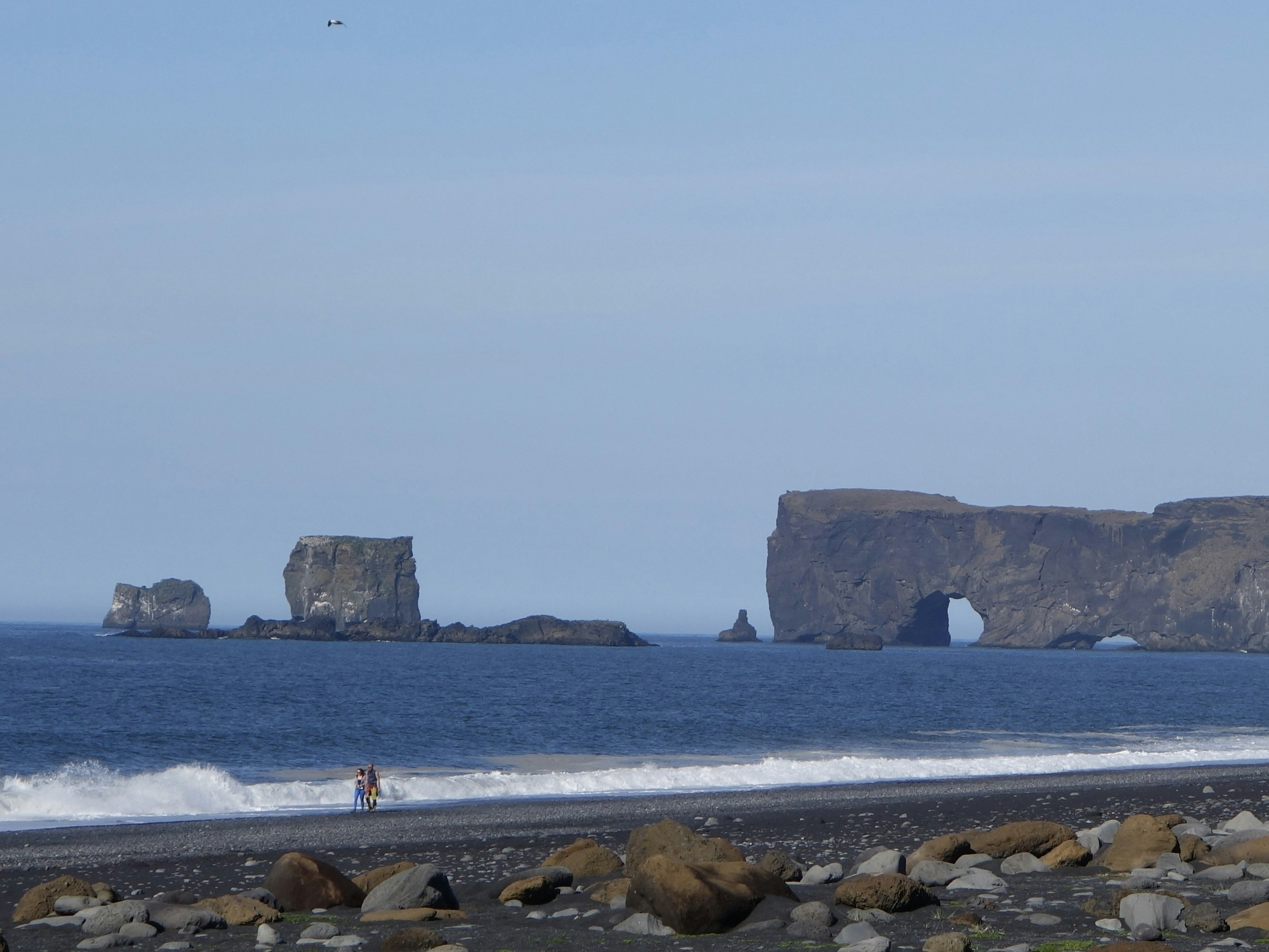 Sea Stack Vista: a quiet shoreline under a pale blue sky