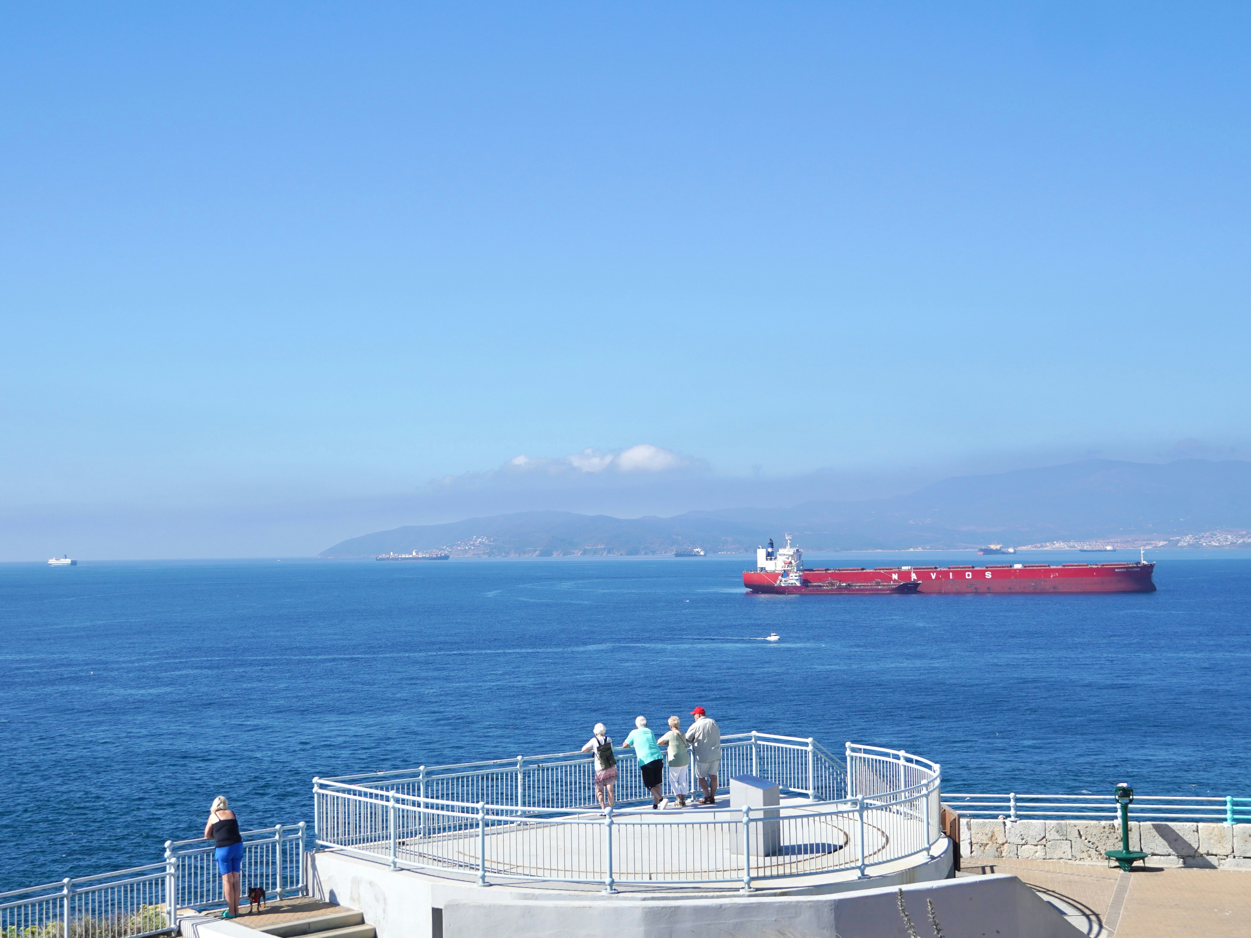 Circular Promenade Overlooking a Freight Vessel on a Calm Atlantic