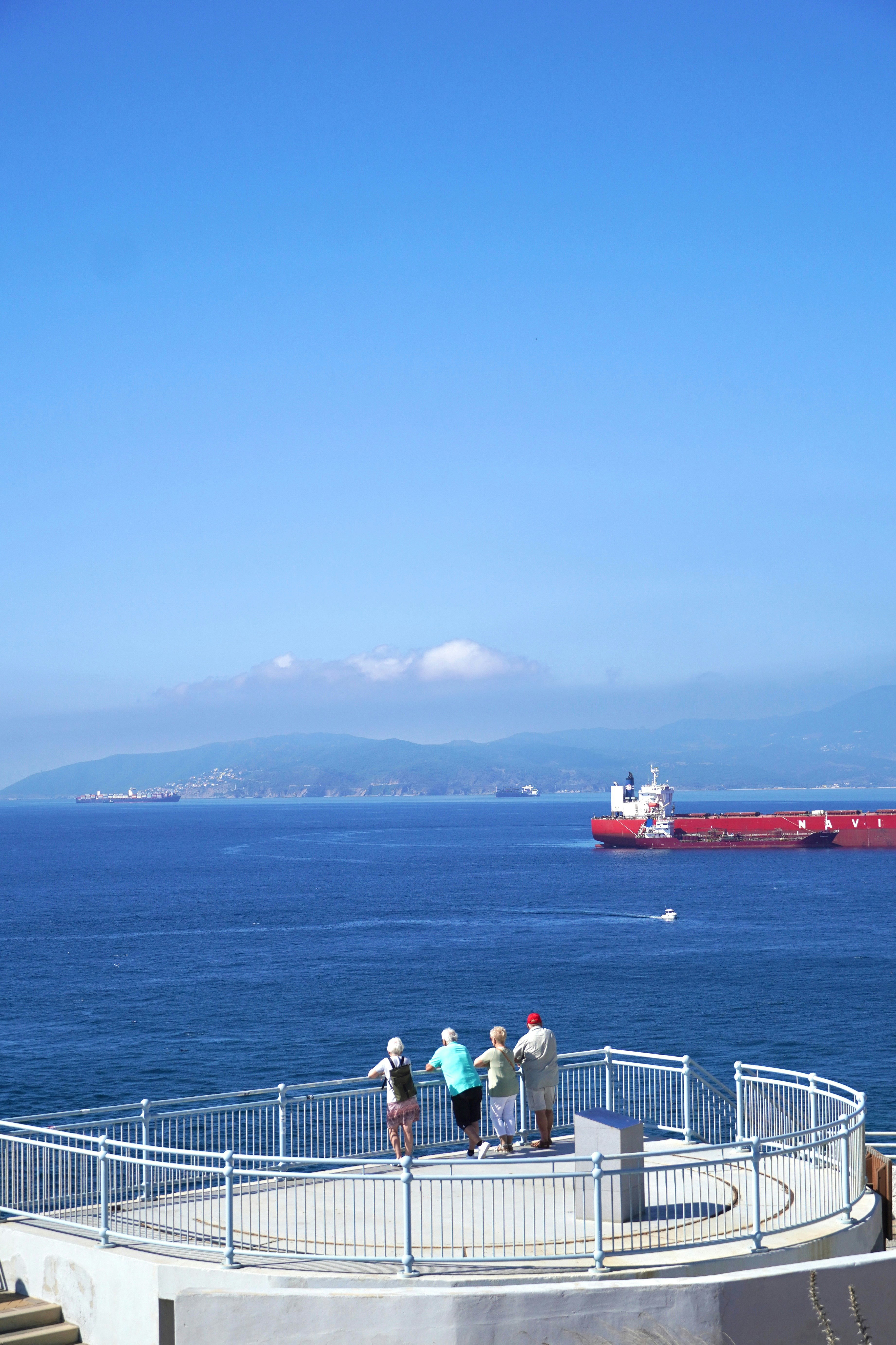 Coastal Lookout: Guided by the Horizon and a Red Vessel