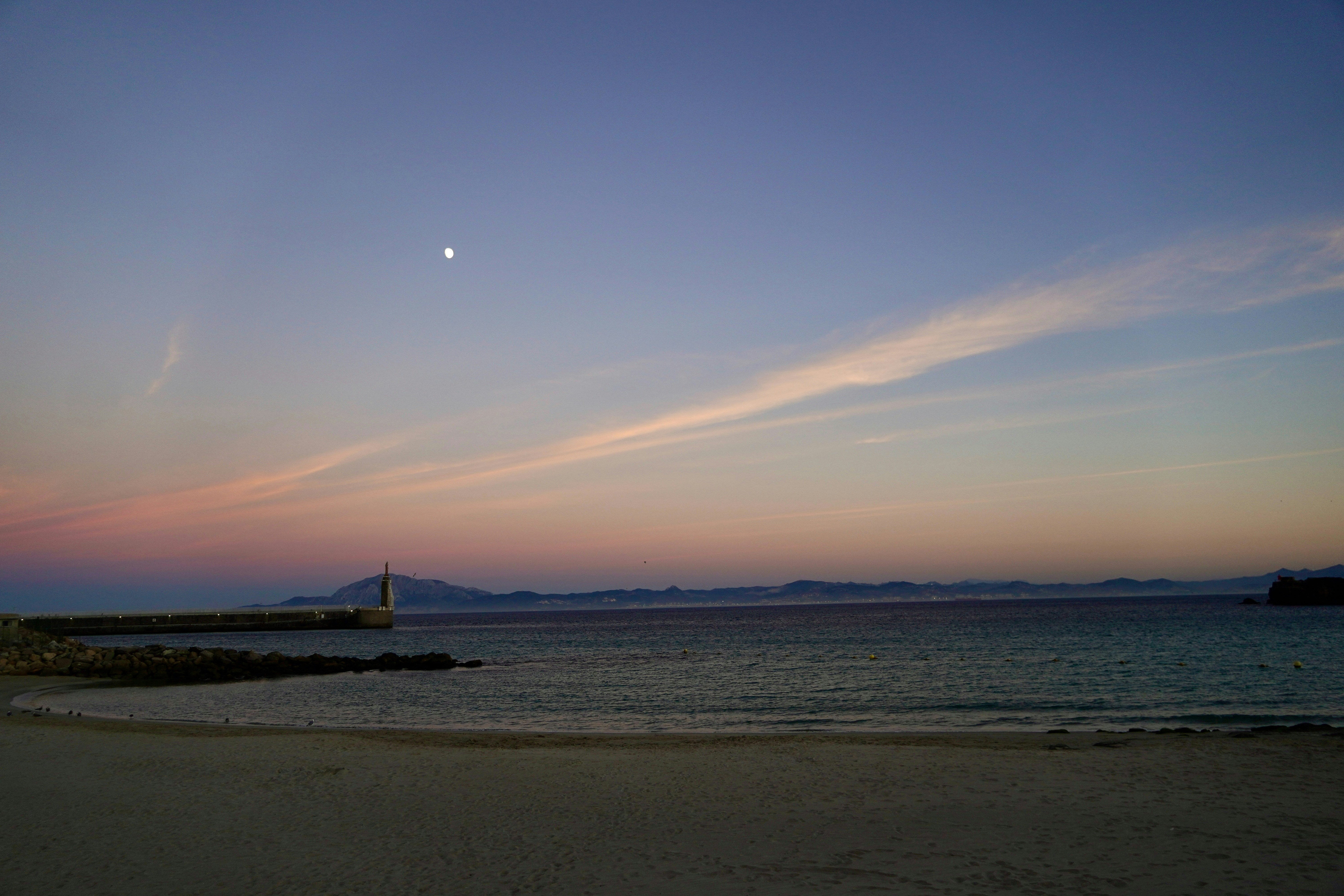 Twilight Pier and Moon over a Quiet Seaside