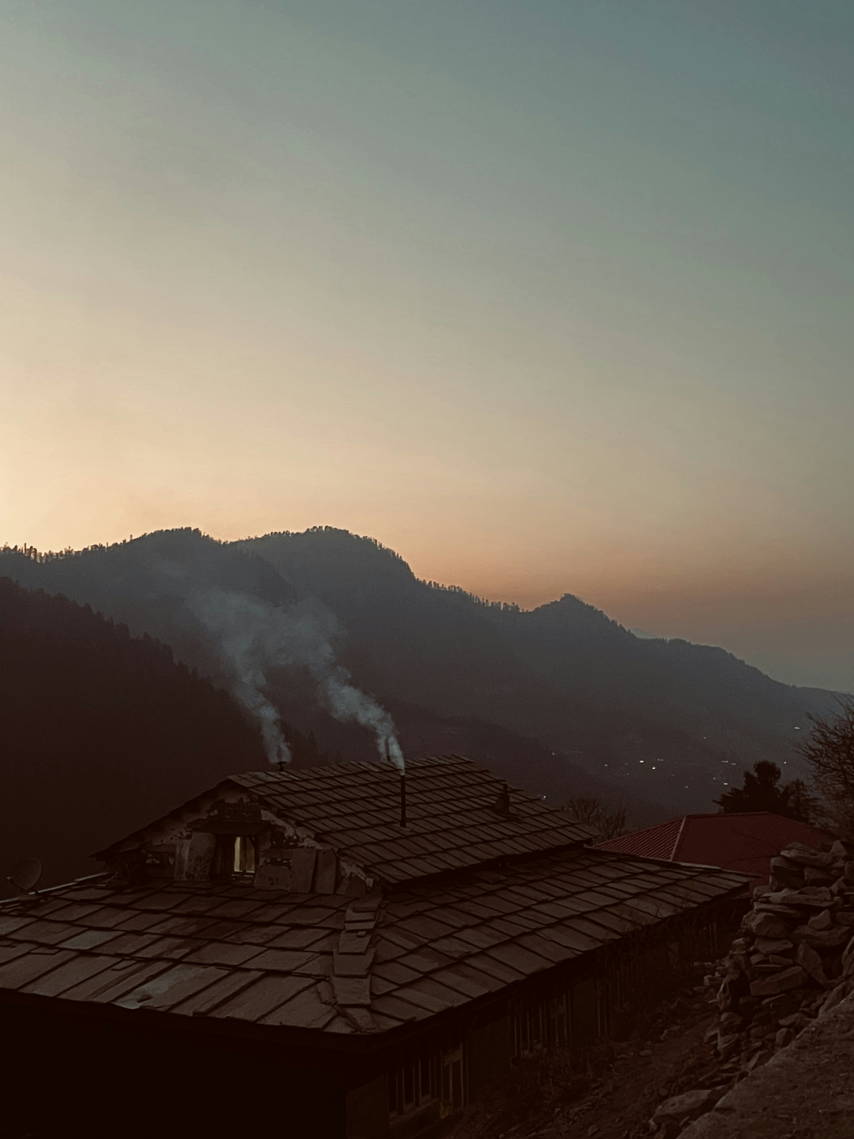 Smoldering Roofs at Dusk Over Mountain Ridge