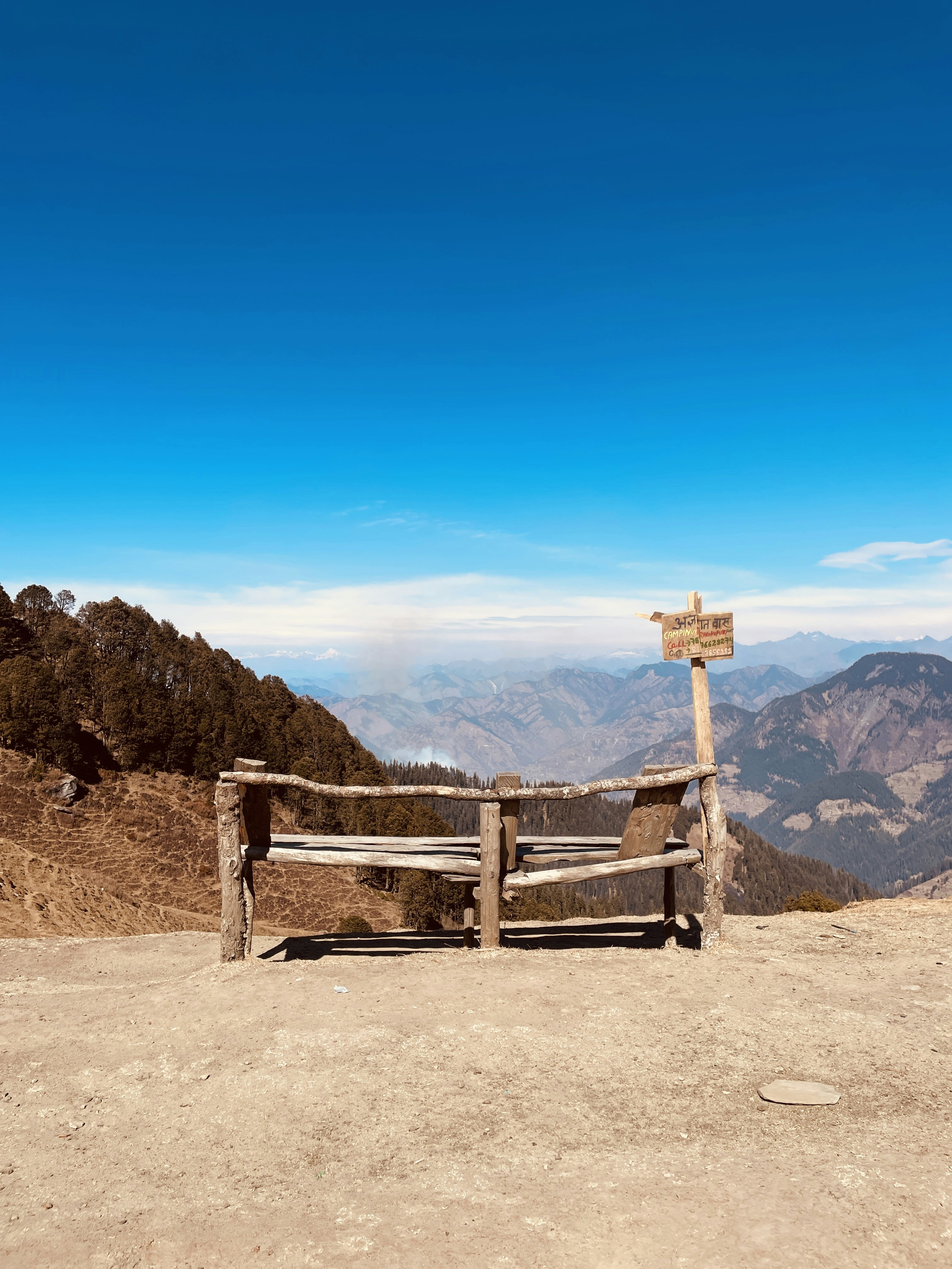 Empty Bench at a Mountain Vista Under a Clear Blue Sky