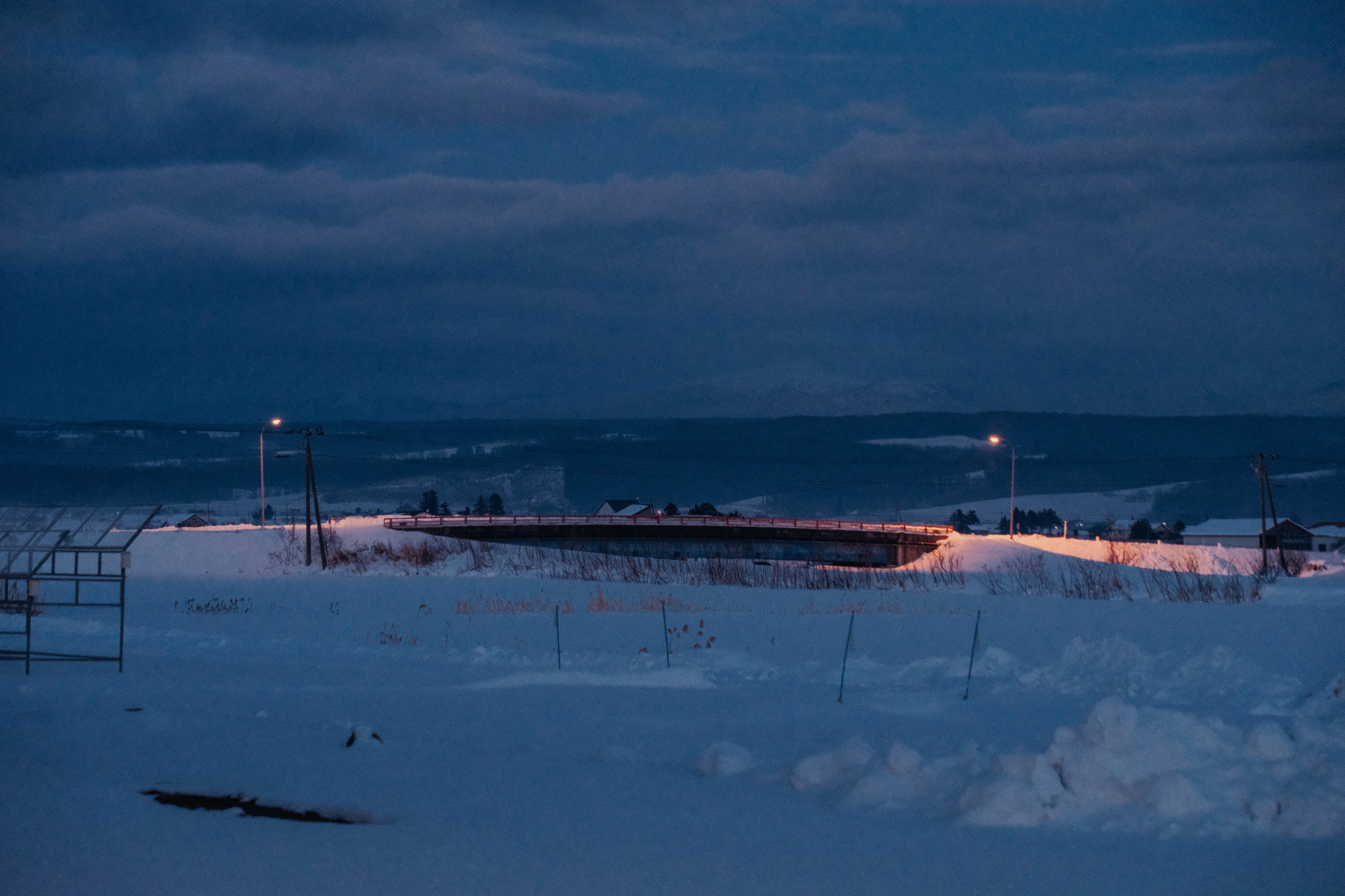 Snow-lit Sea Wall under a Cold Evening Sky