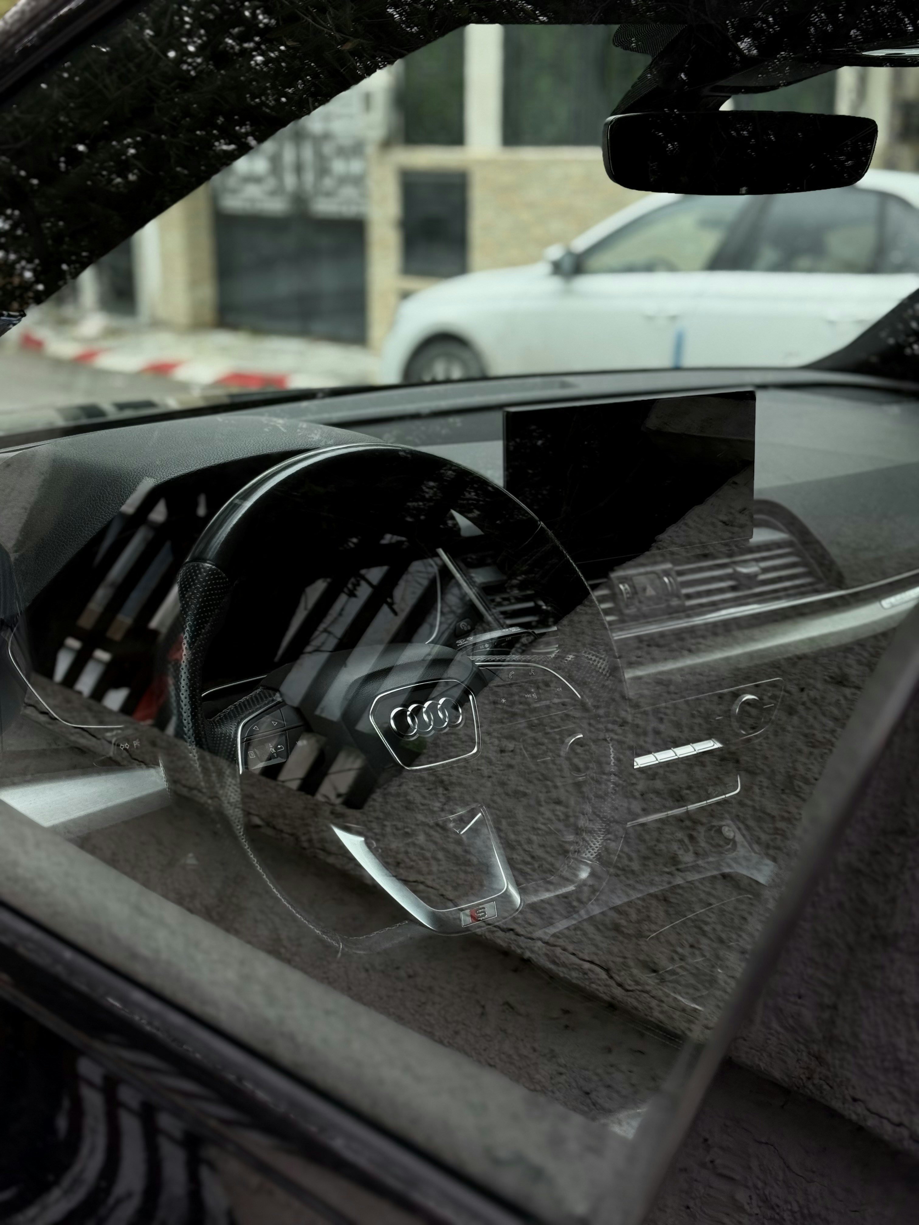 Reflected Cockpit: An Audi Inside a Car with Glass Overlay