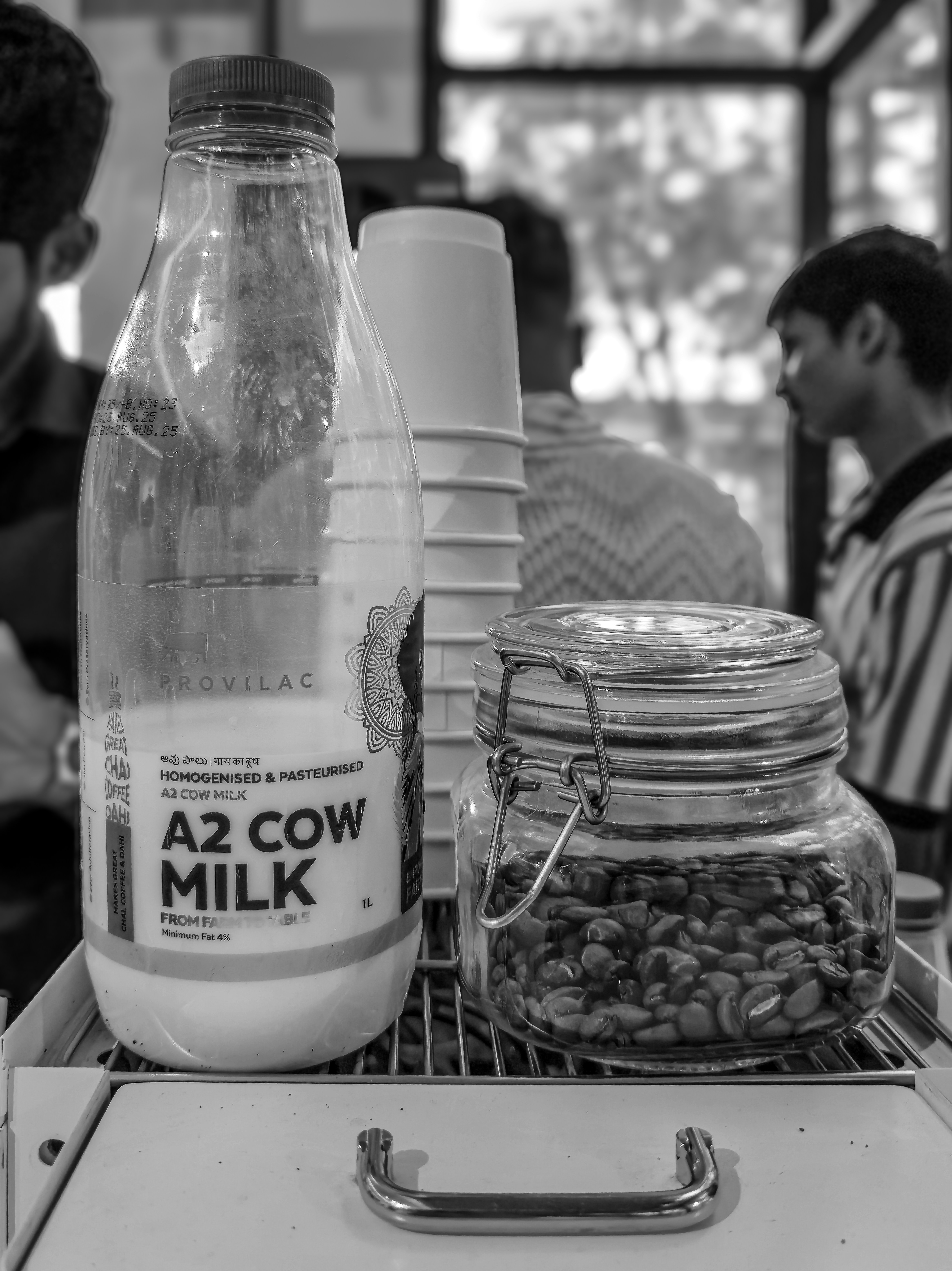 Milk Bottle and Cocoa Beans: Quiet Café Portrait in Black and White