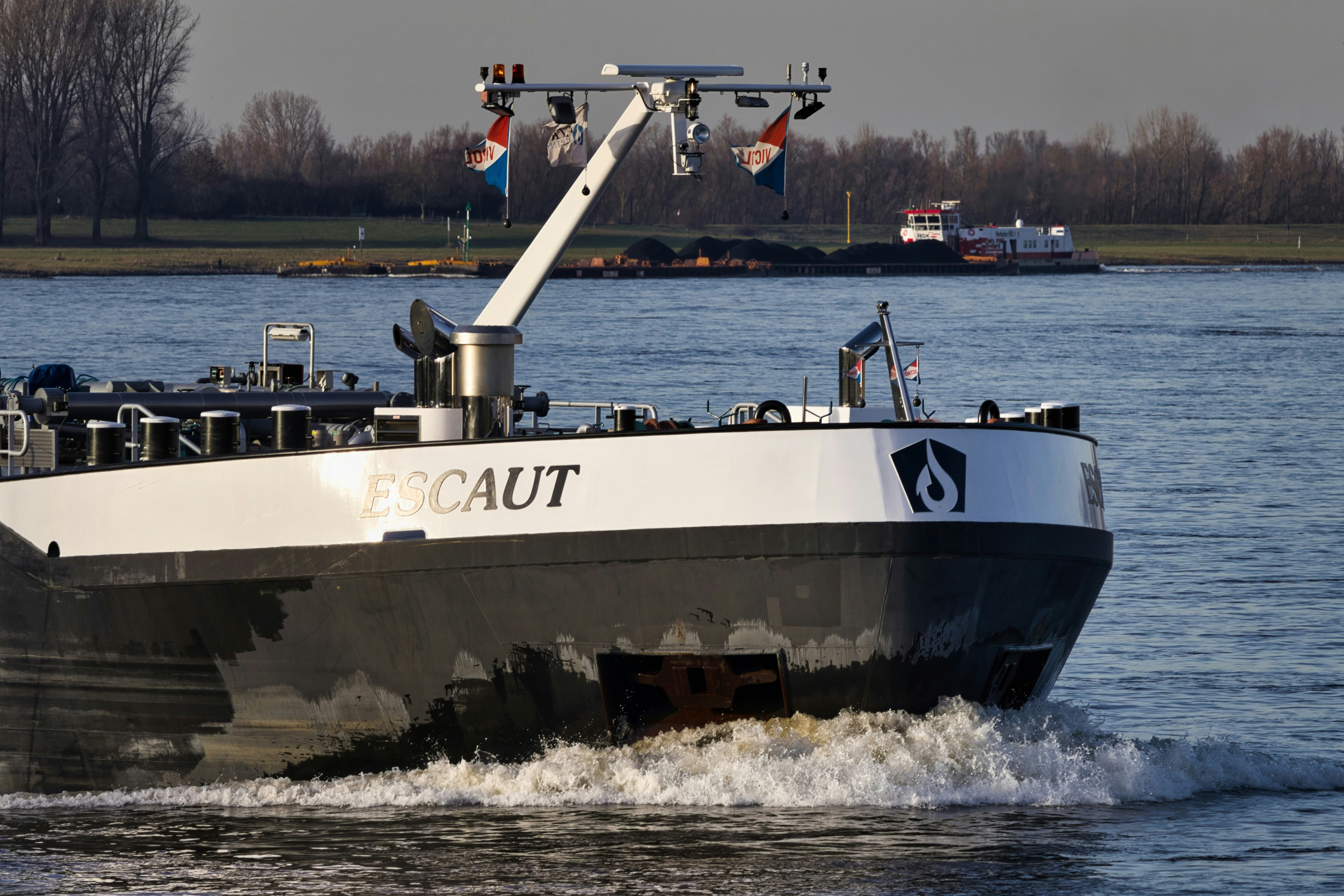 Bow Wave and Prow Mark: A Cargo Tow Clears the Channel