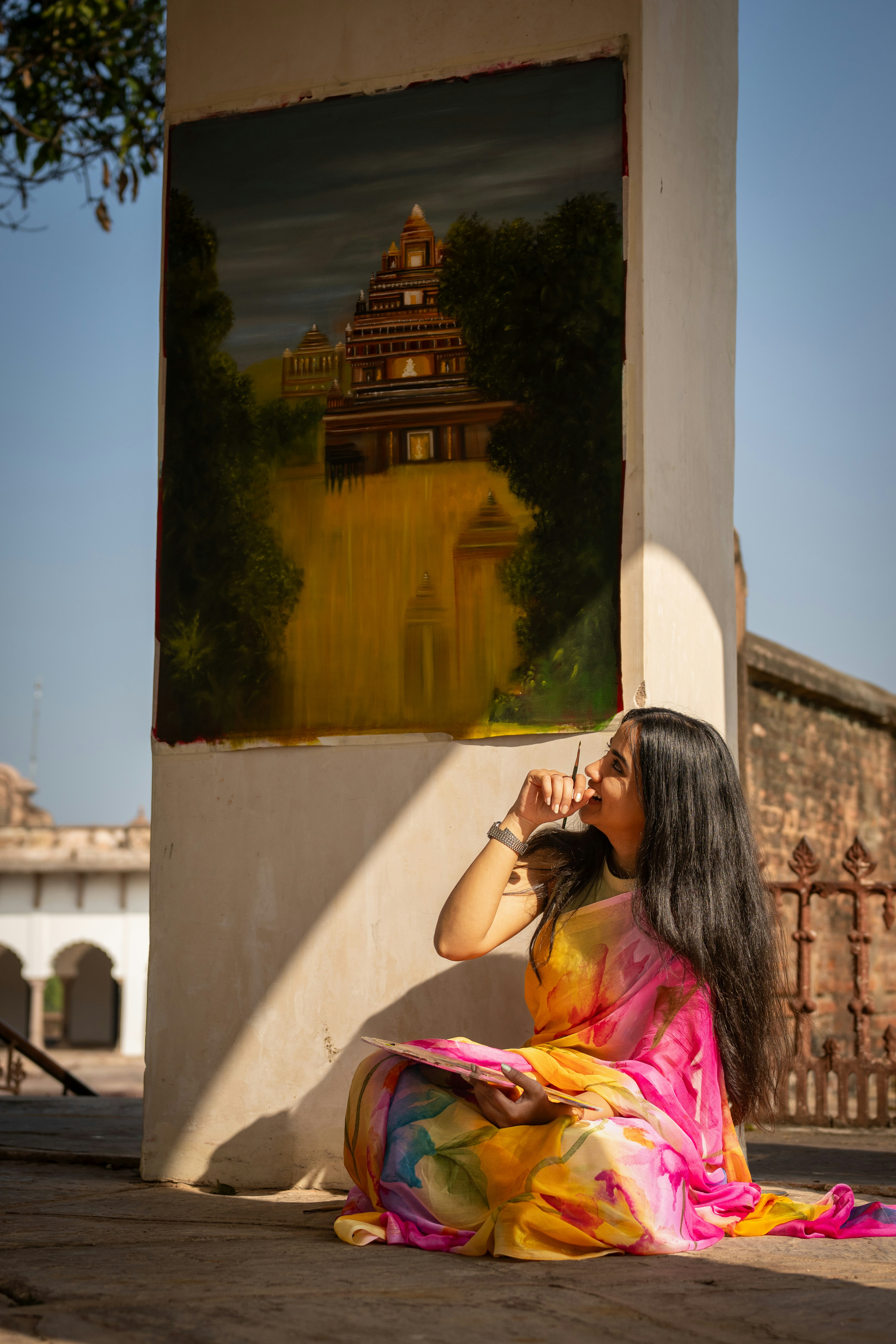 Silk Saree in the Shade: A Quiet Moment by the Painted Pillar