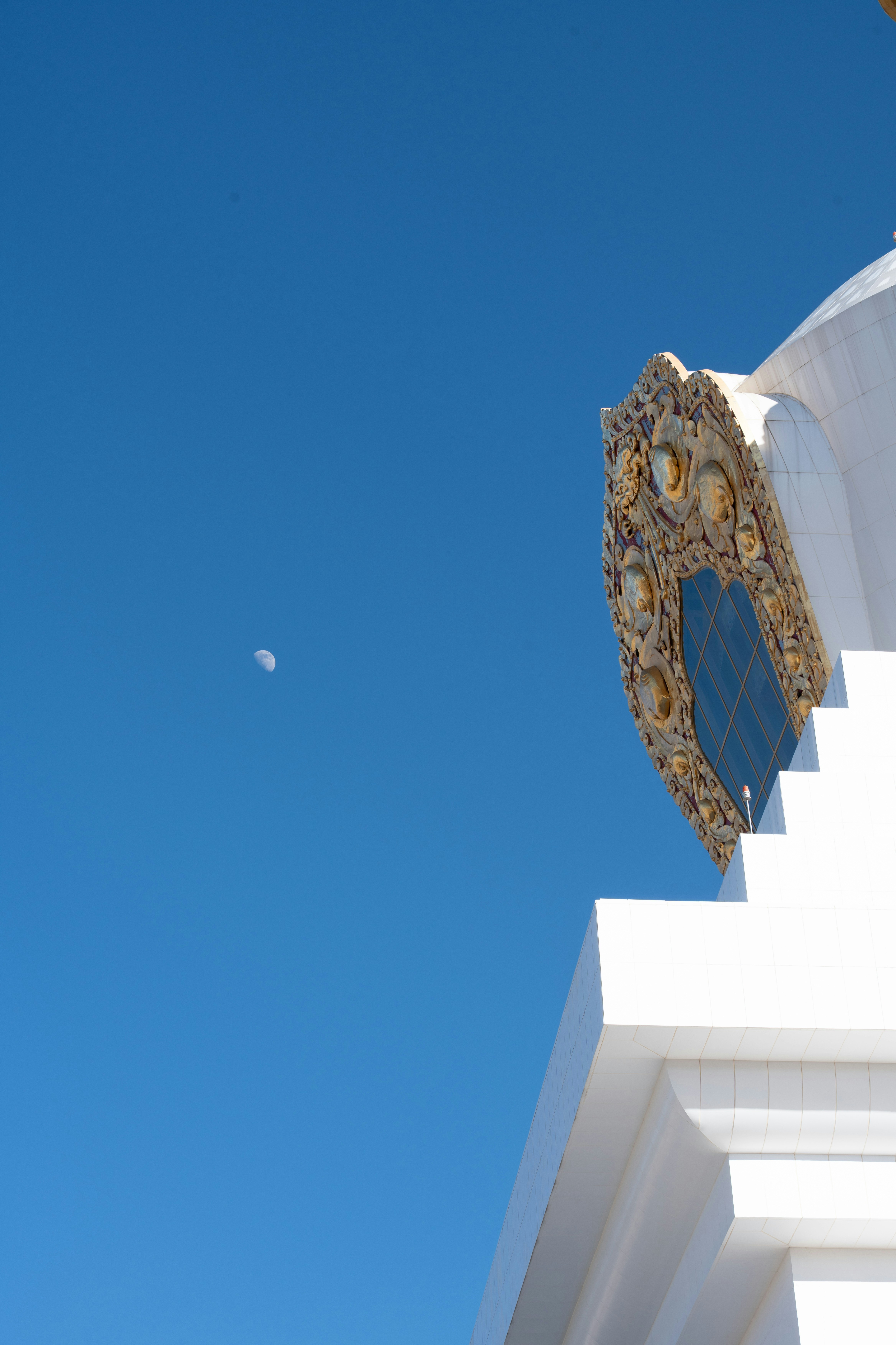 Moonlit Crest: Ornament and Sky Above a White Facade