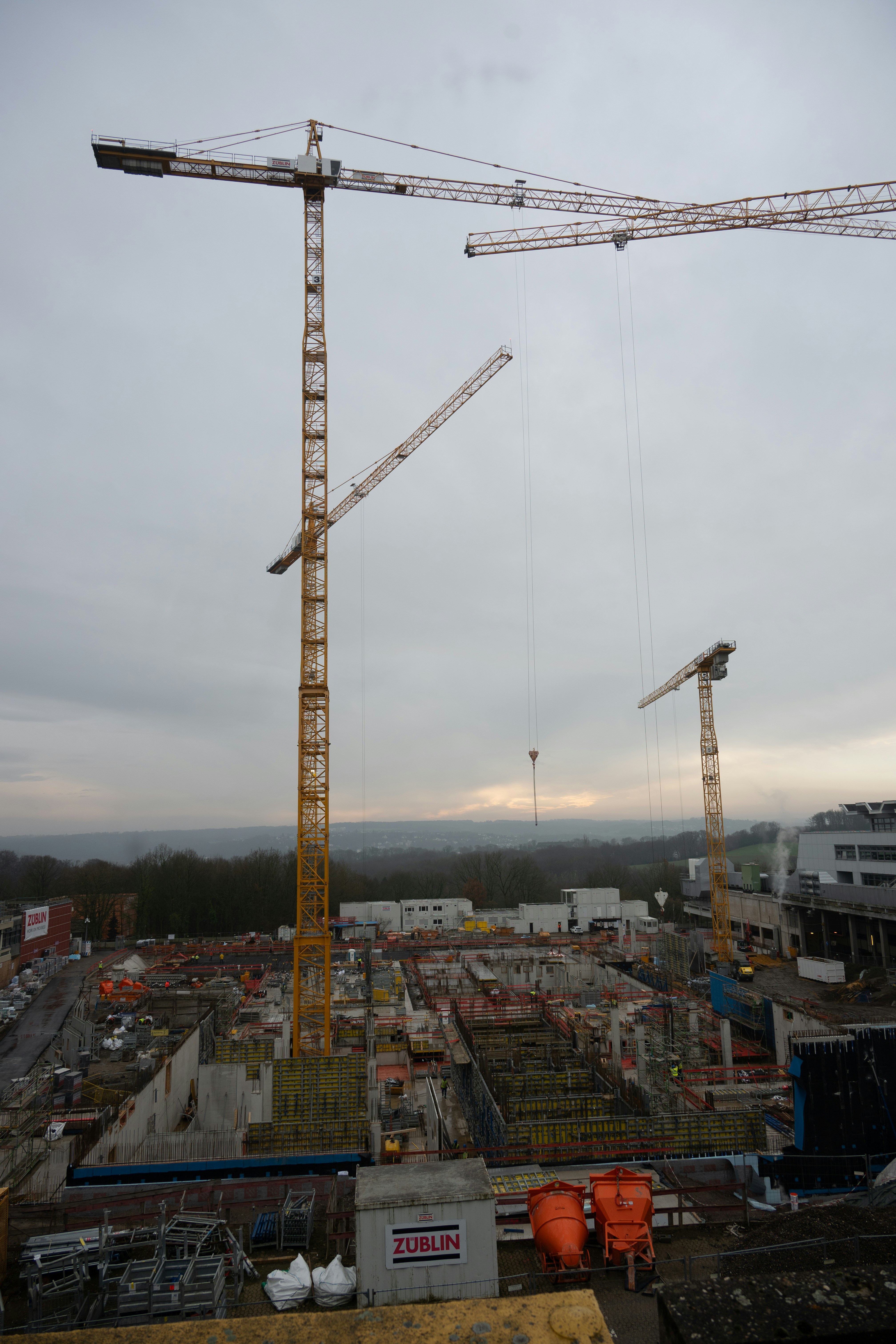 Towering Cranes Over a Neon-City Frame